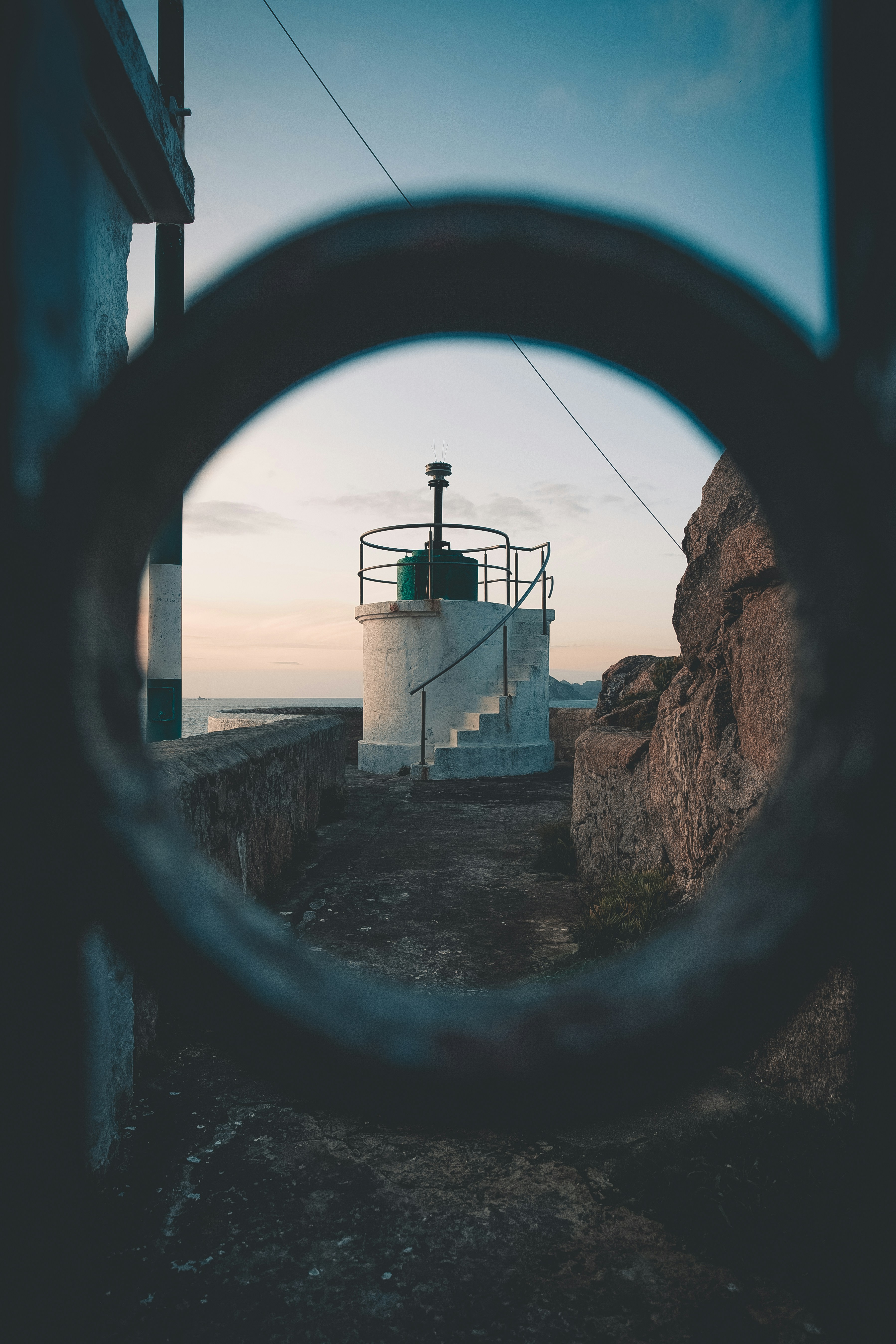 Through the Ring: a coastal beacon framed by a circular aperture