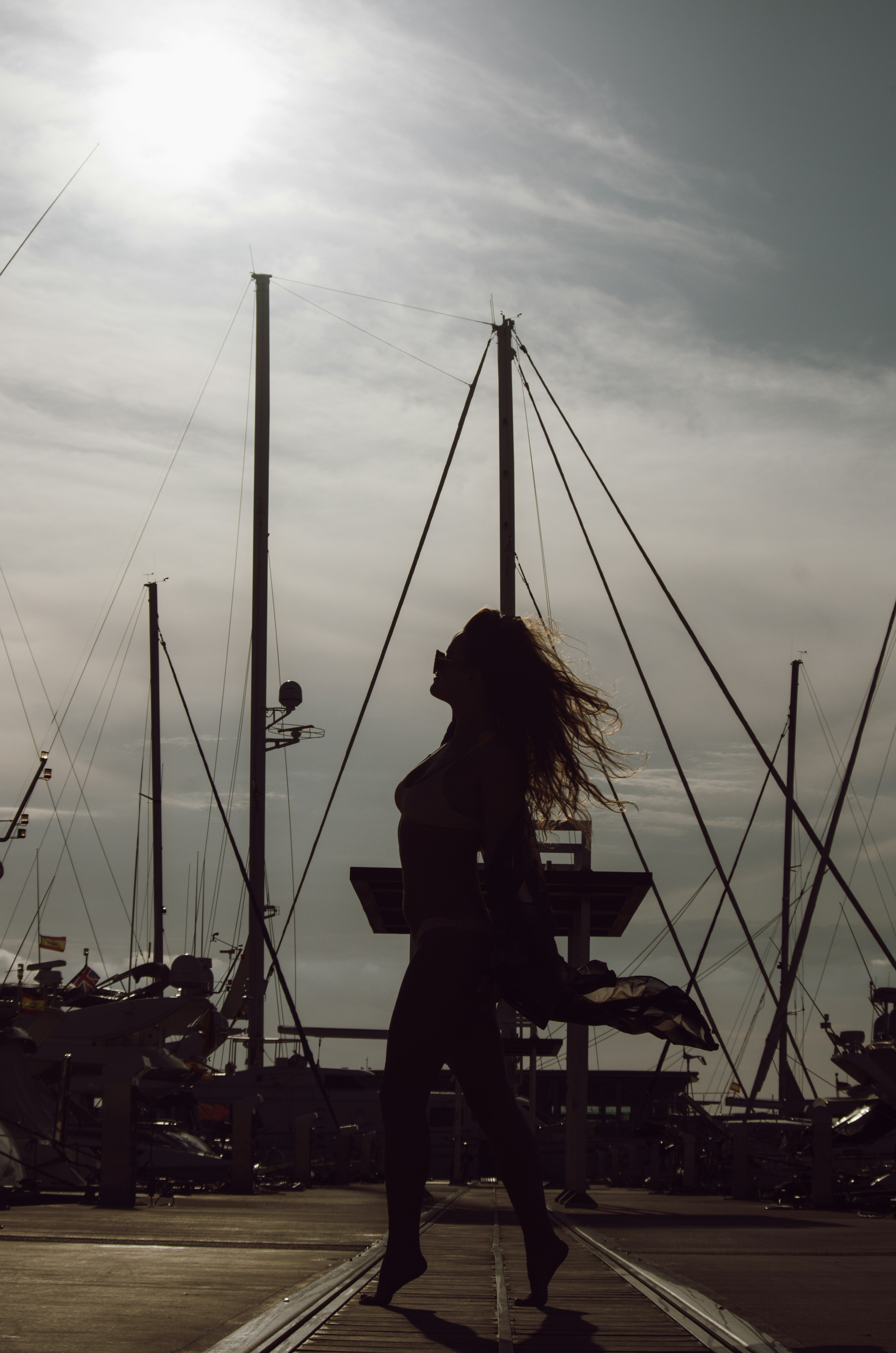 woman standing on road near boat during daytime