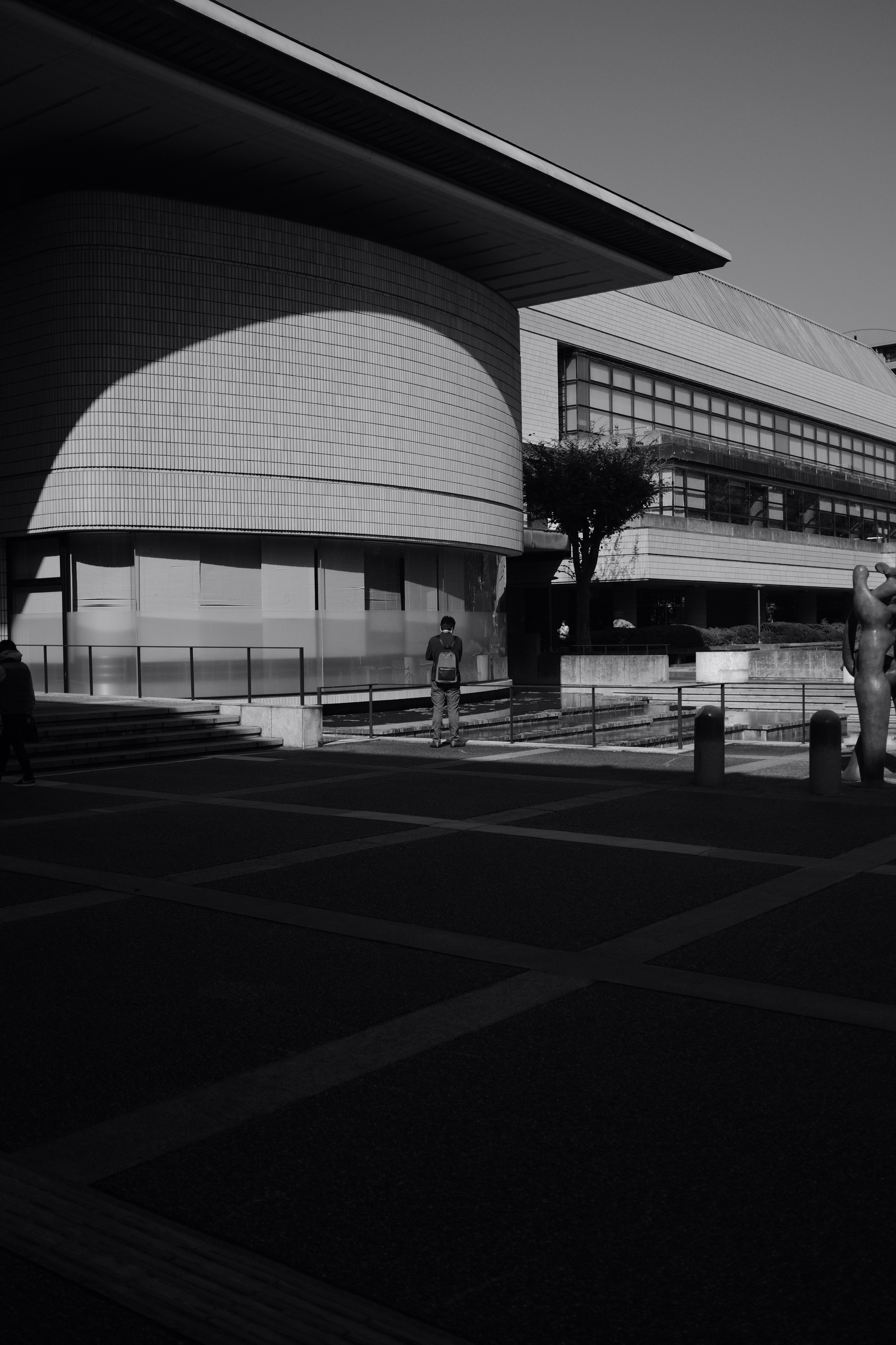 Grayscale photography of person standing near building photo – Free ...