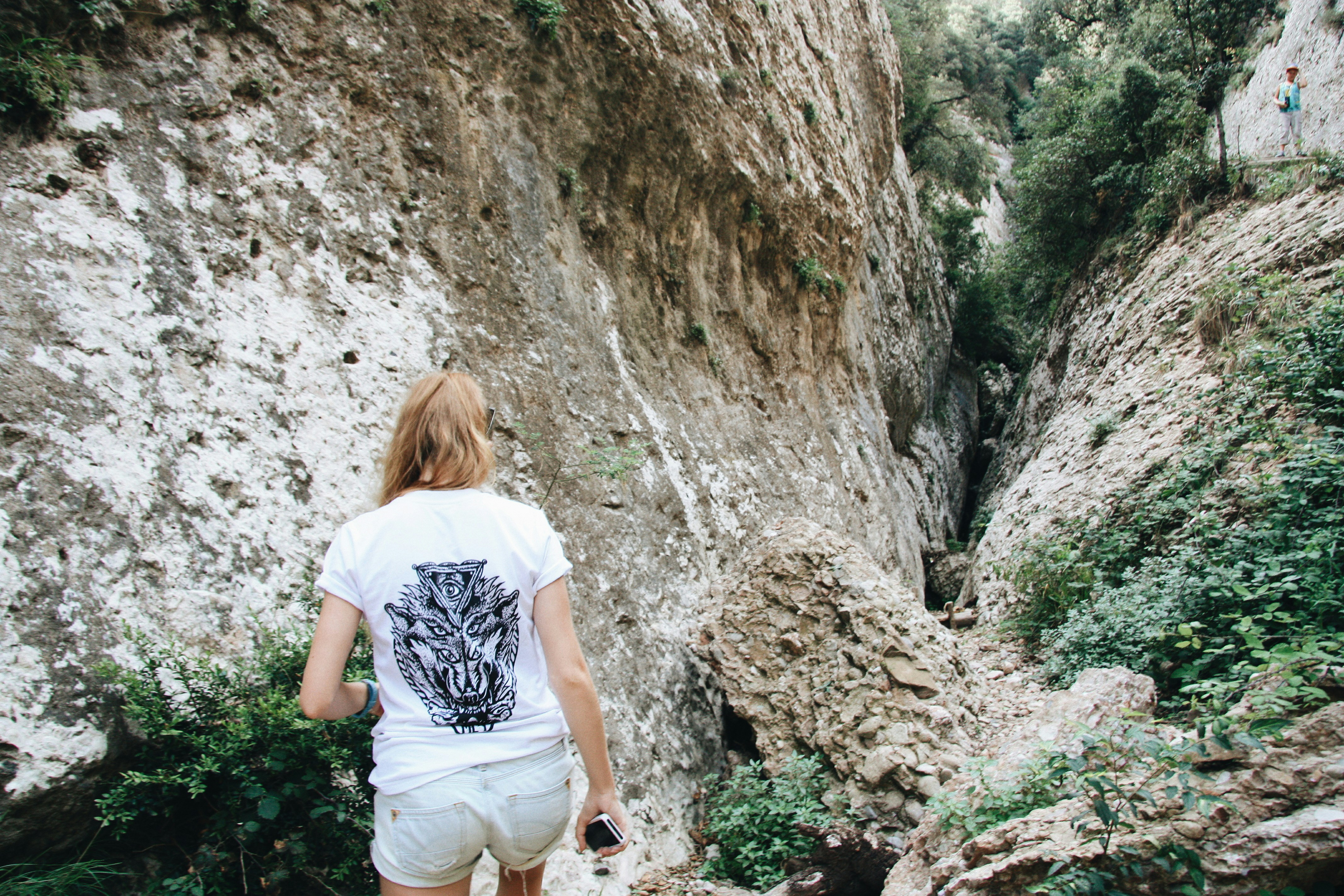 White-Tee Wanderer Through a Limestone Gorge