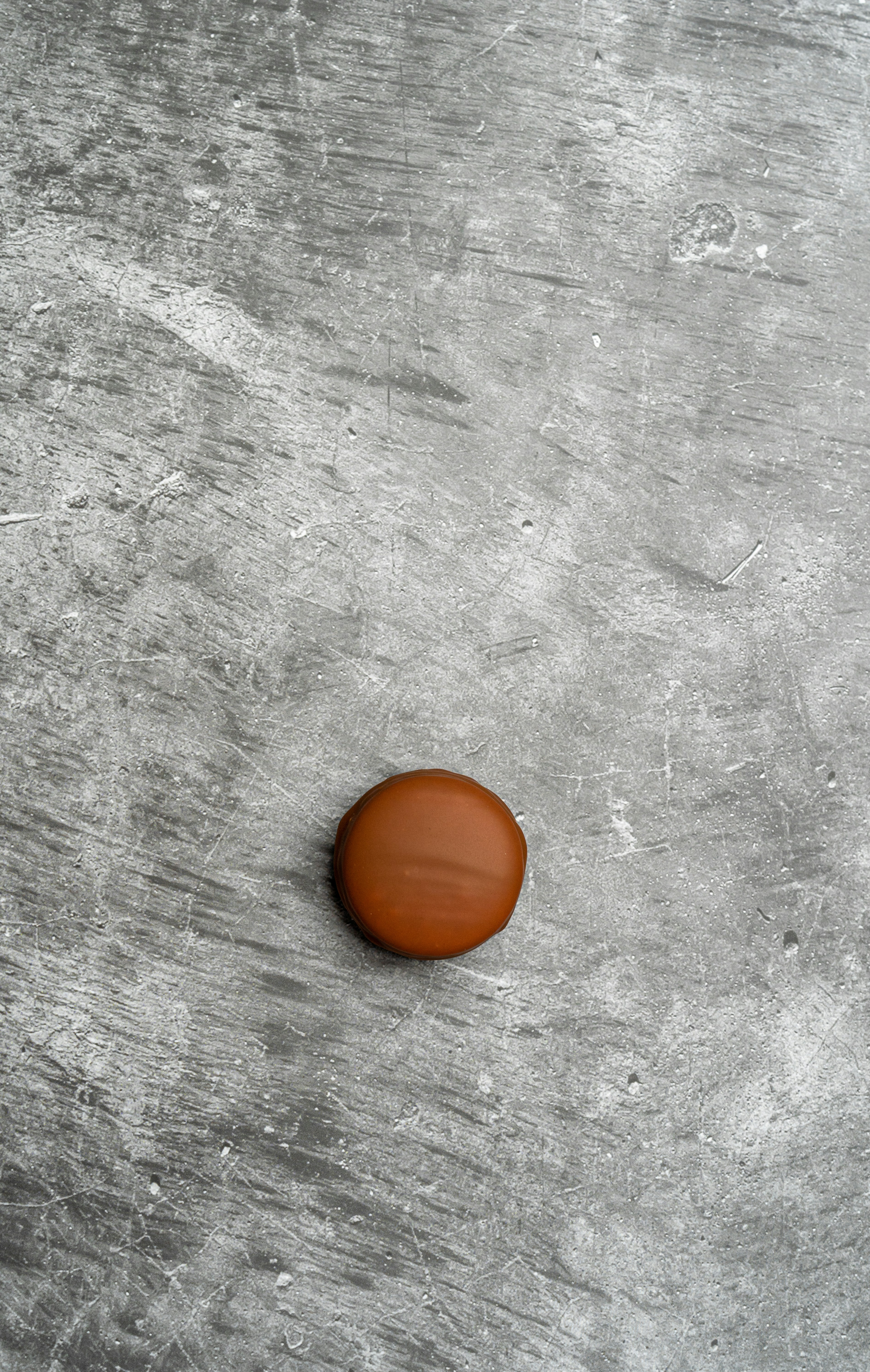 Terracotta Orb on a Scratched Steel Stage