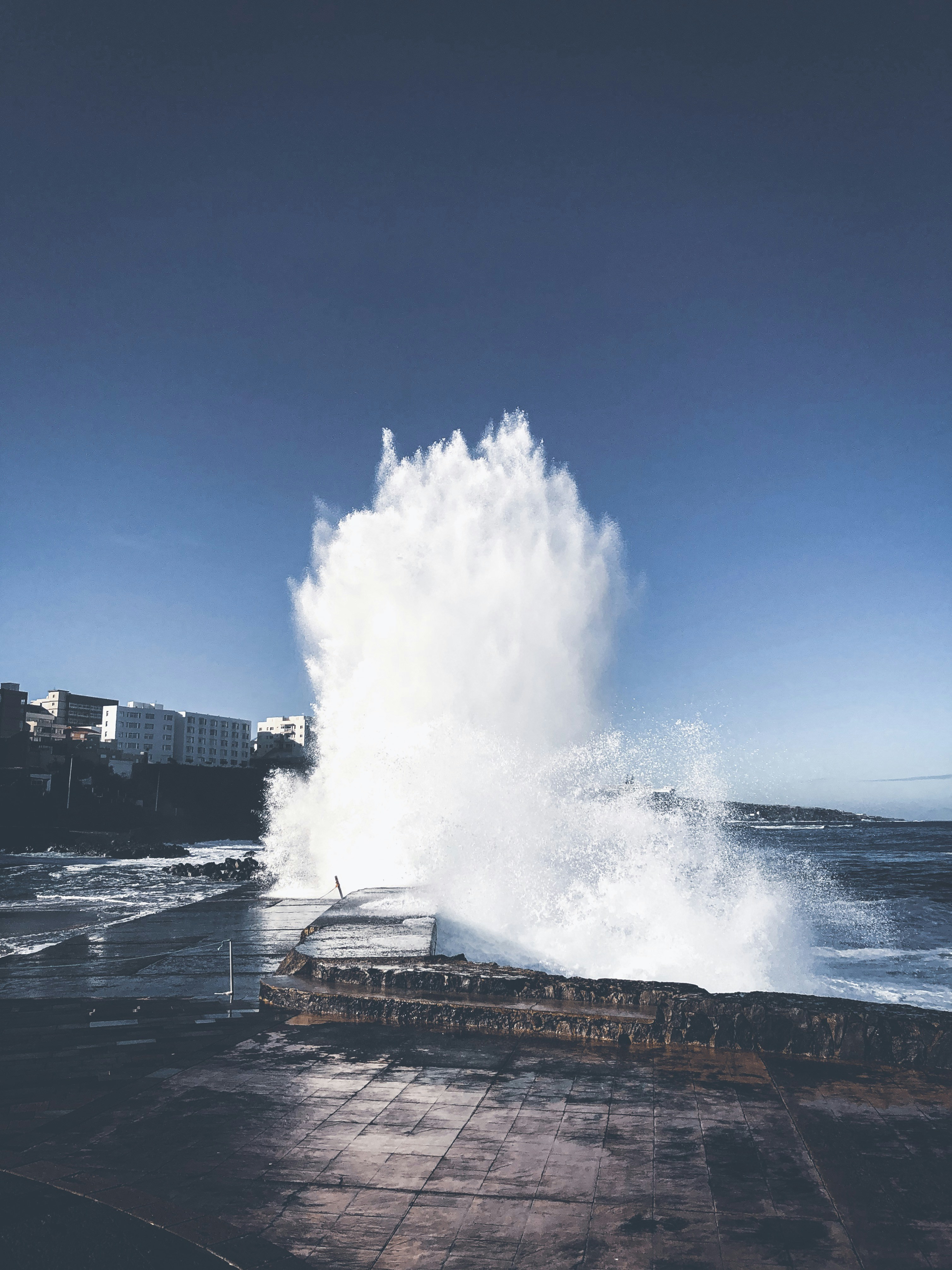 Crescendo of Spray: Wave-Driven Fountain on a Rigid Breakwater