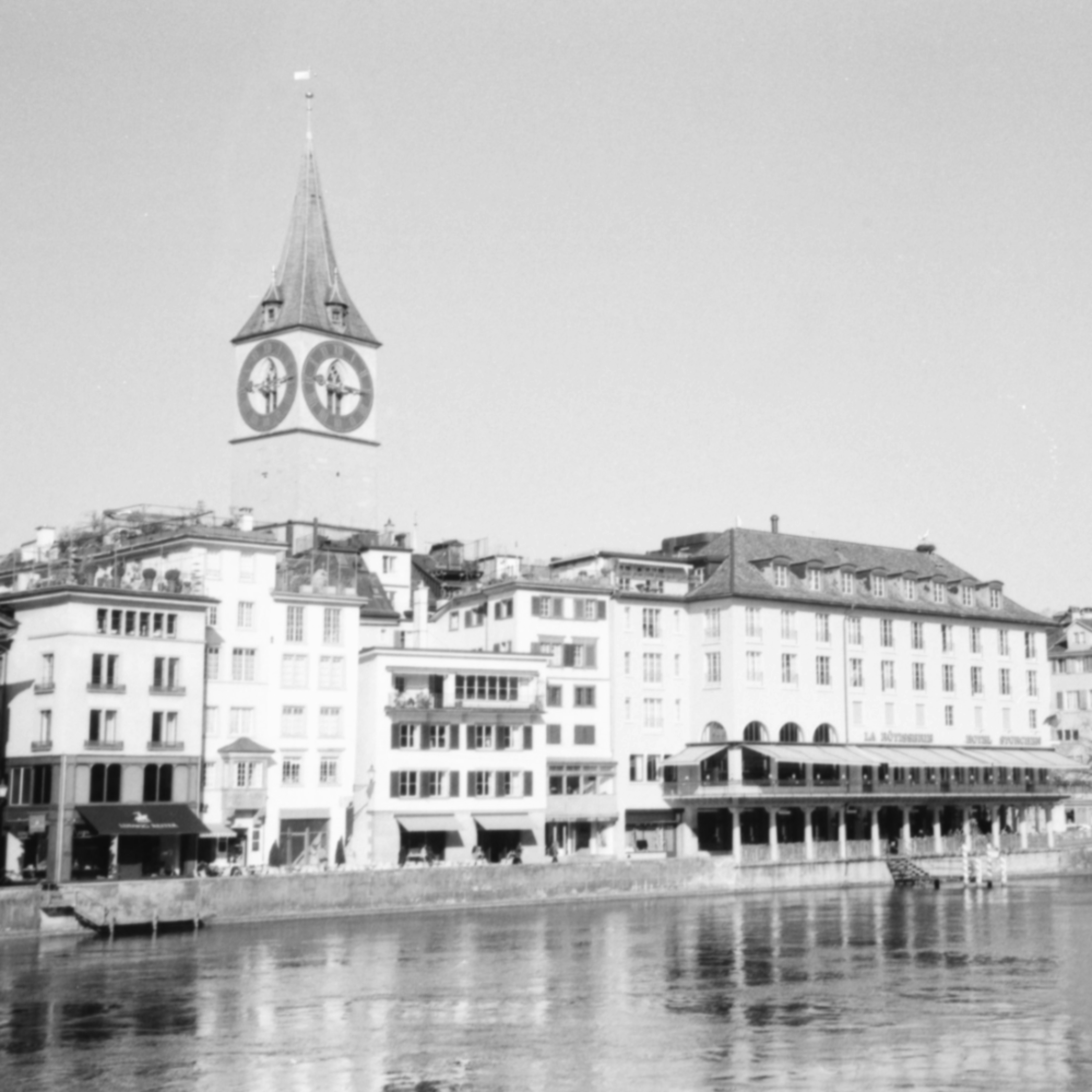 Riverside Clock Tower Above a Quiet European Waterfront Quarter