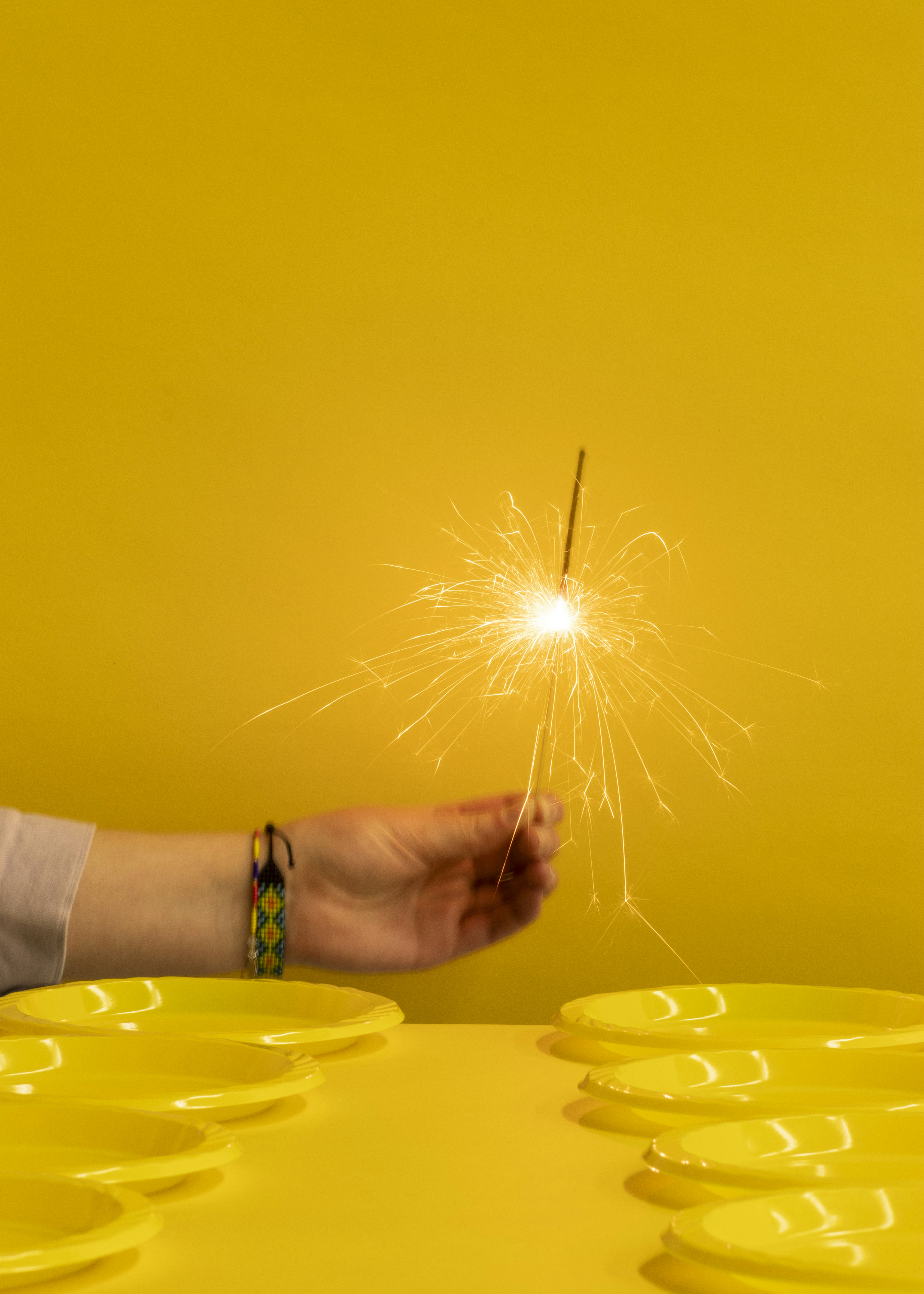 Handheld Sparkler in a Yellow Studio