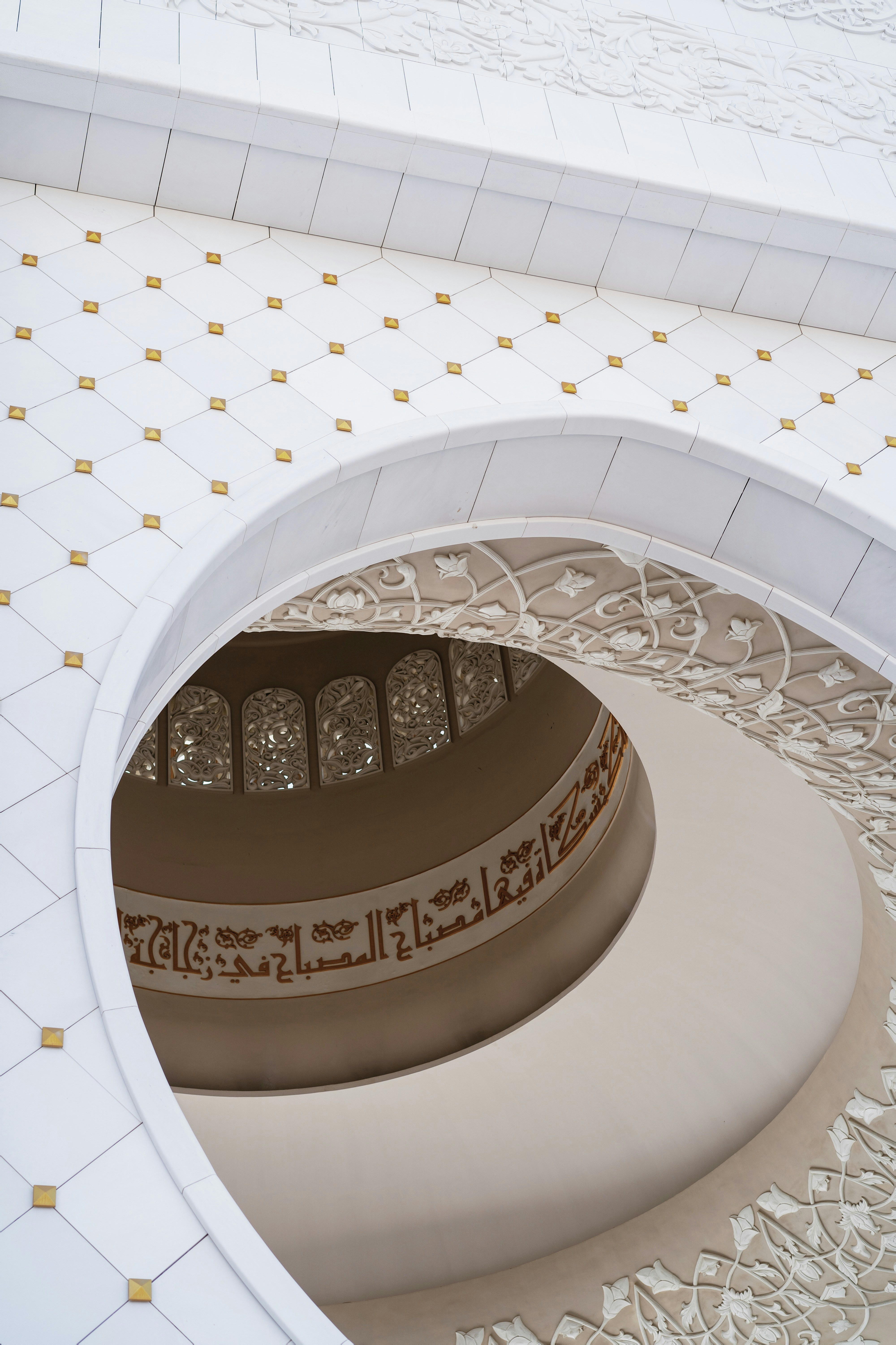 Spiral Archway: A White Marble Descent into Ornate Carvings