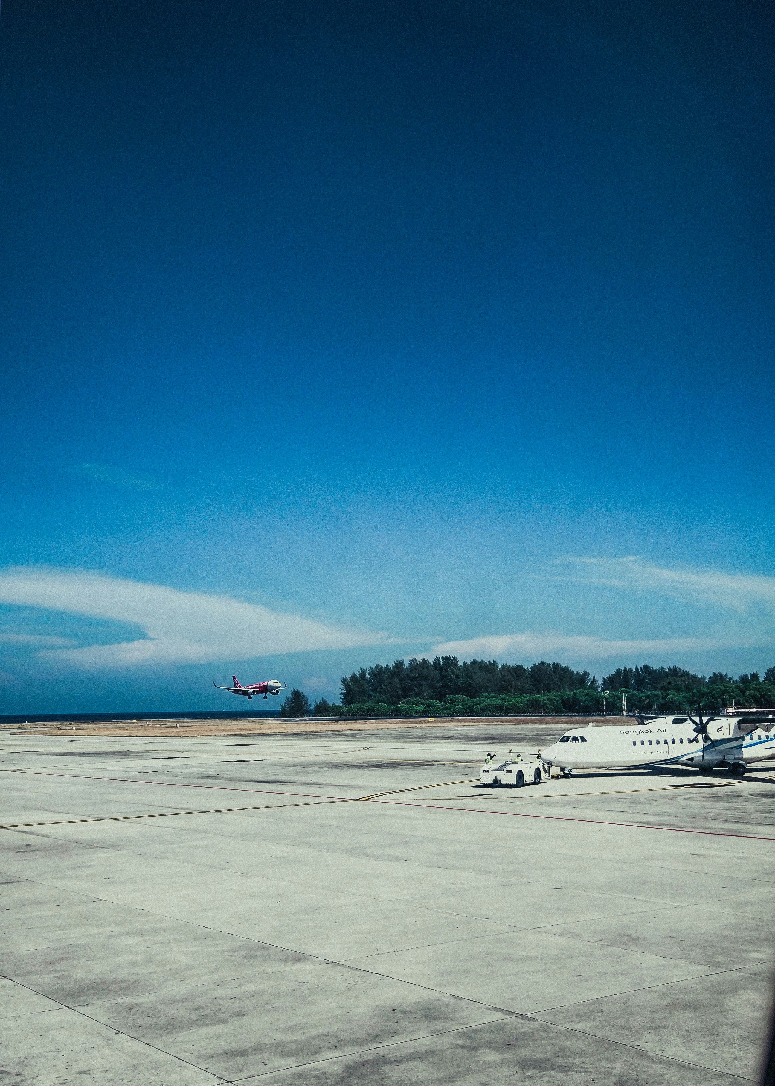 Jet Bridge Quiet: A Moment on the Tarmac with a Distant Arrival