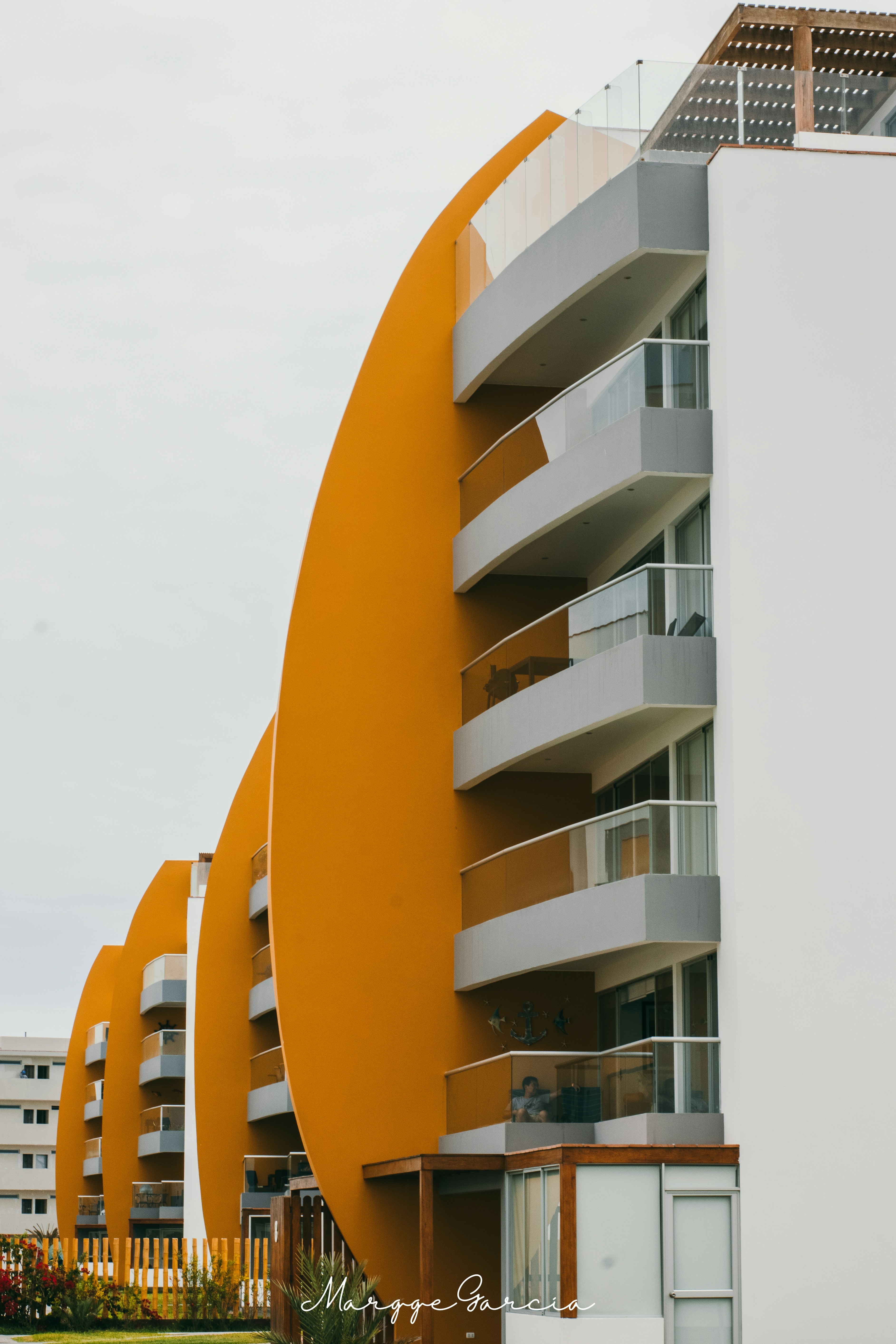 Architectural design featuring bold, curved facades of residential buildings in a contemporary setting.