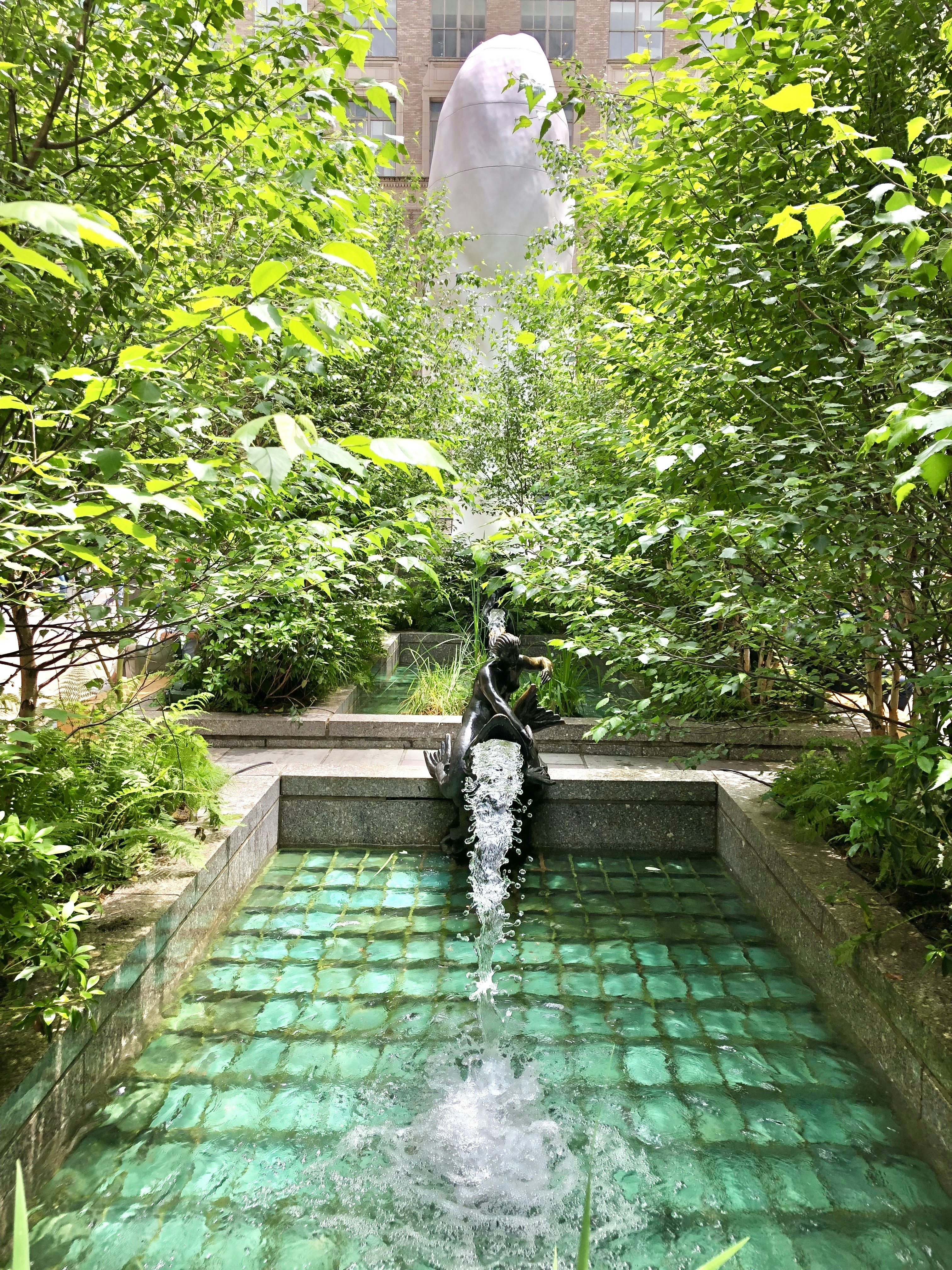 Garden Fountain Portrait: Greenery Framing a Waterfall of Stone