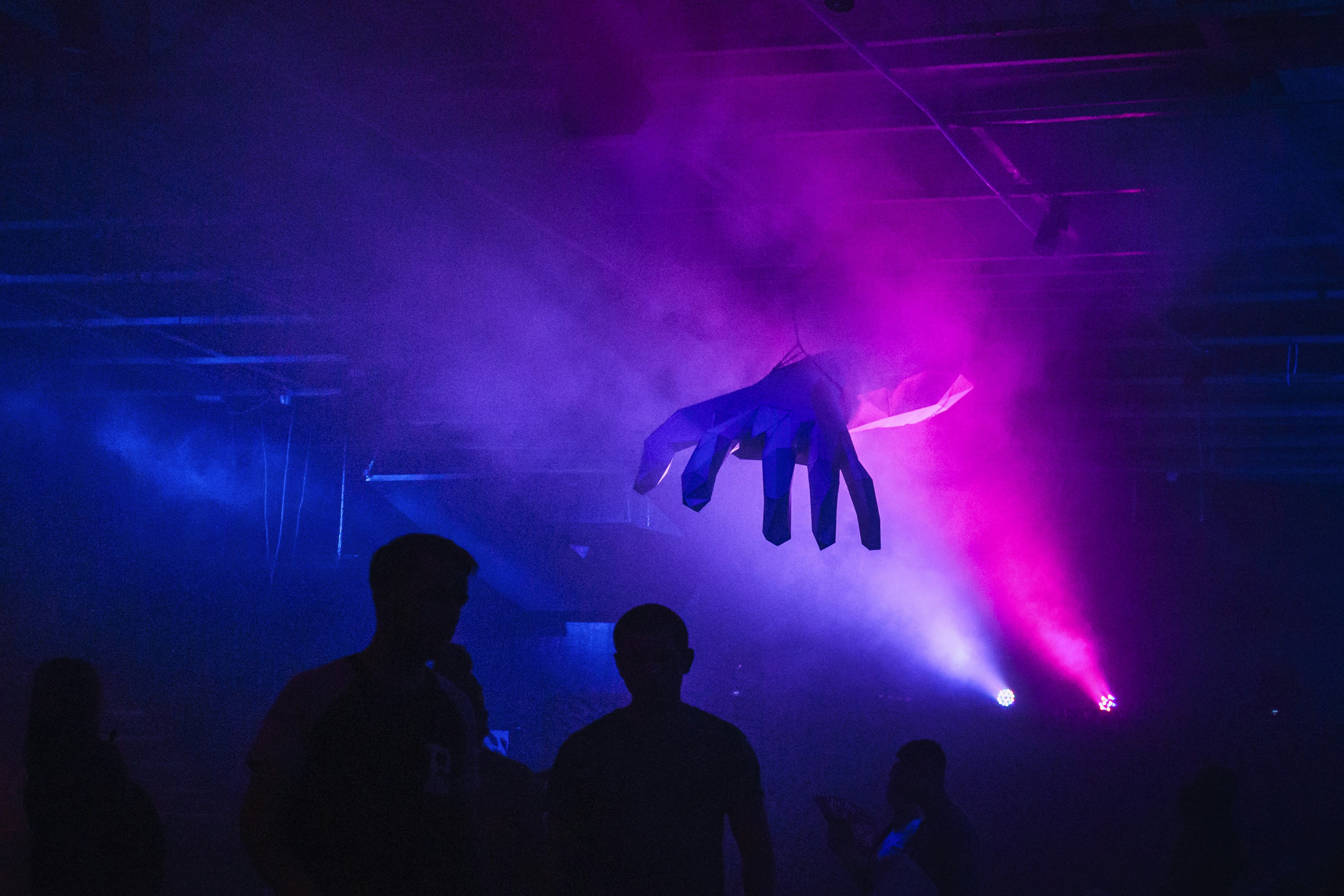 A person's hand hanging from the ceiling of a dark room photo – Free ...