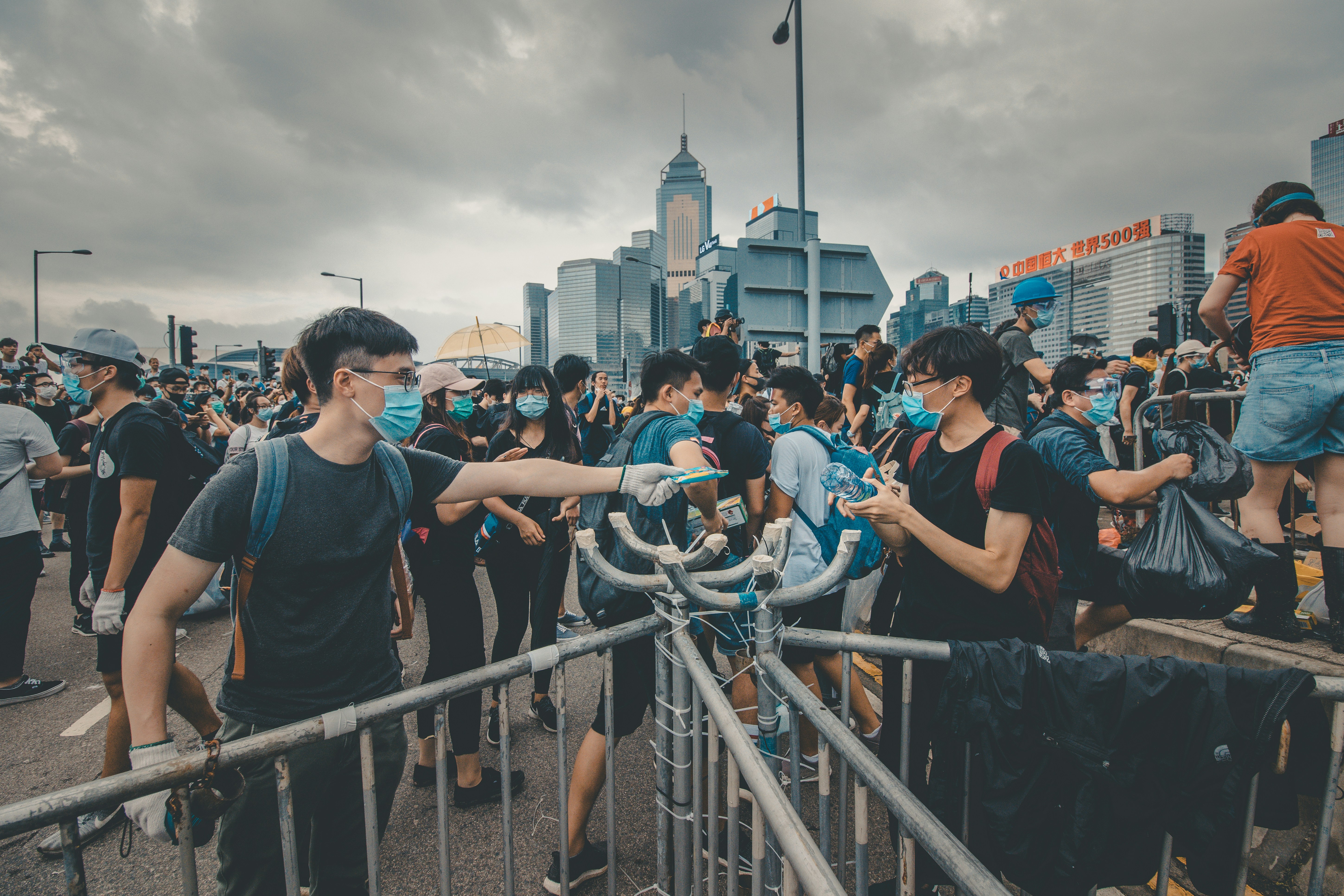 Men standing beside metal fences photo – Free Human Image on Unsplash