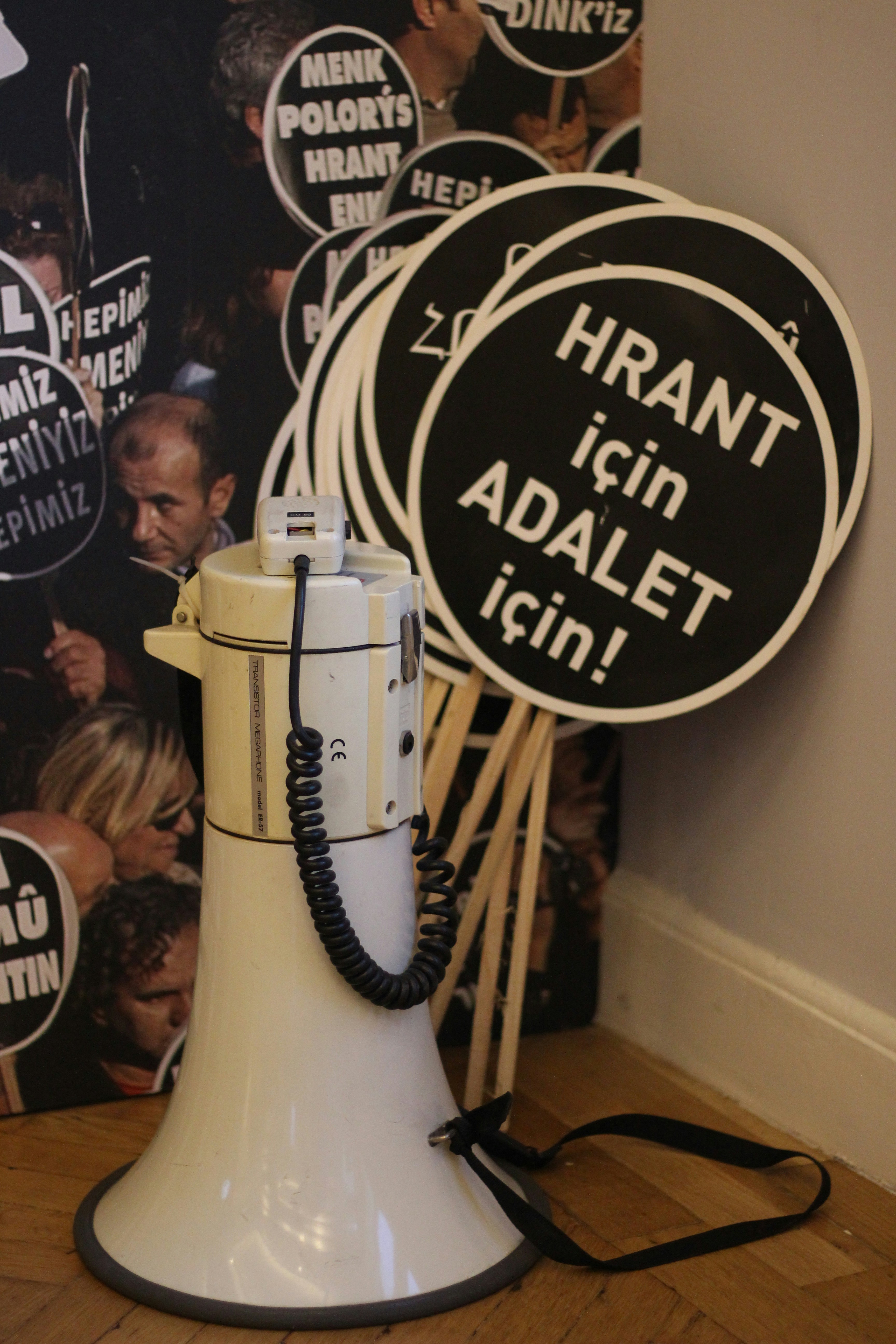 Megaphone Stand with Protest Signs in a Crowd Backdrop