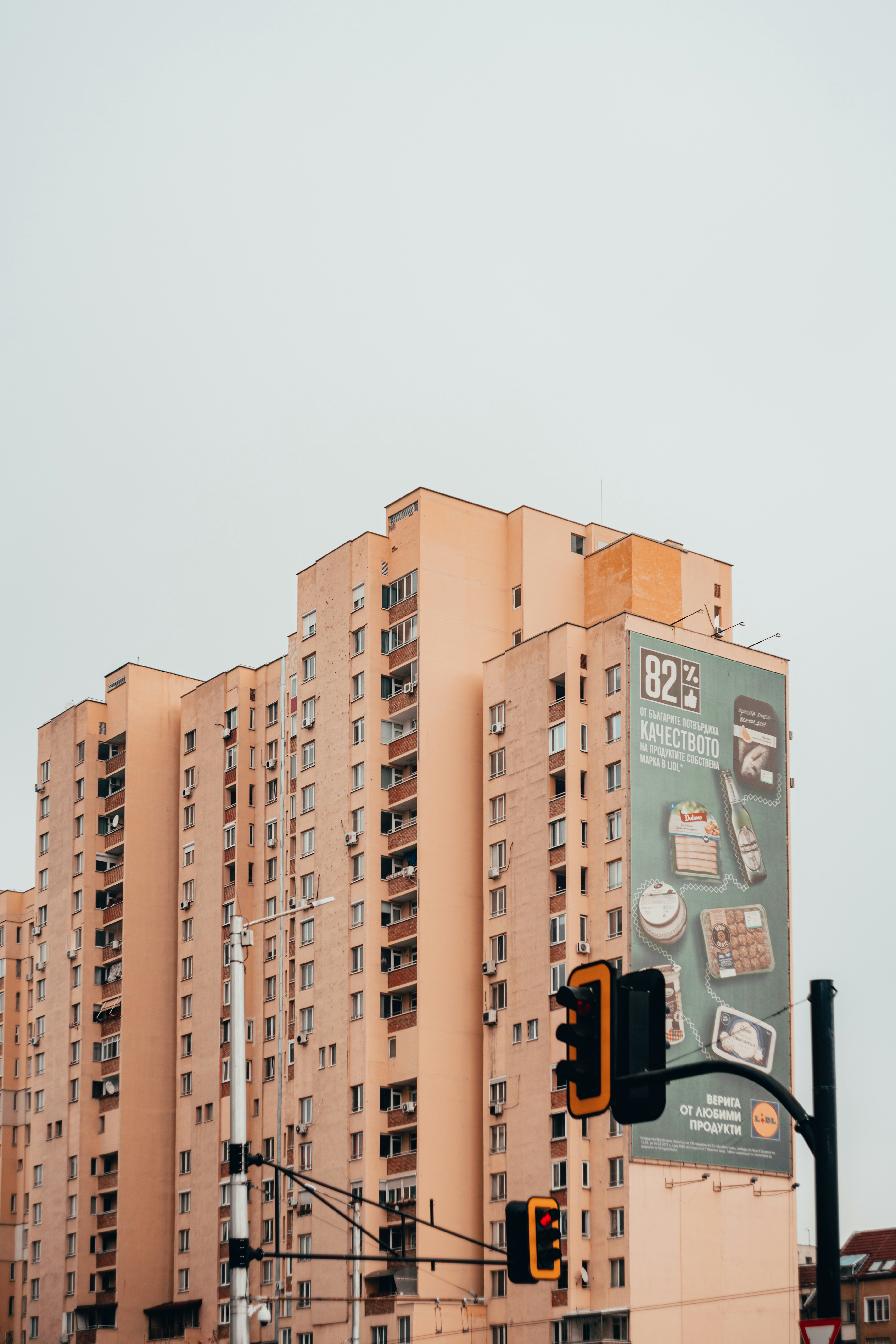 Urban towers rise with a billboard sentinel