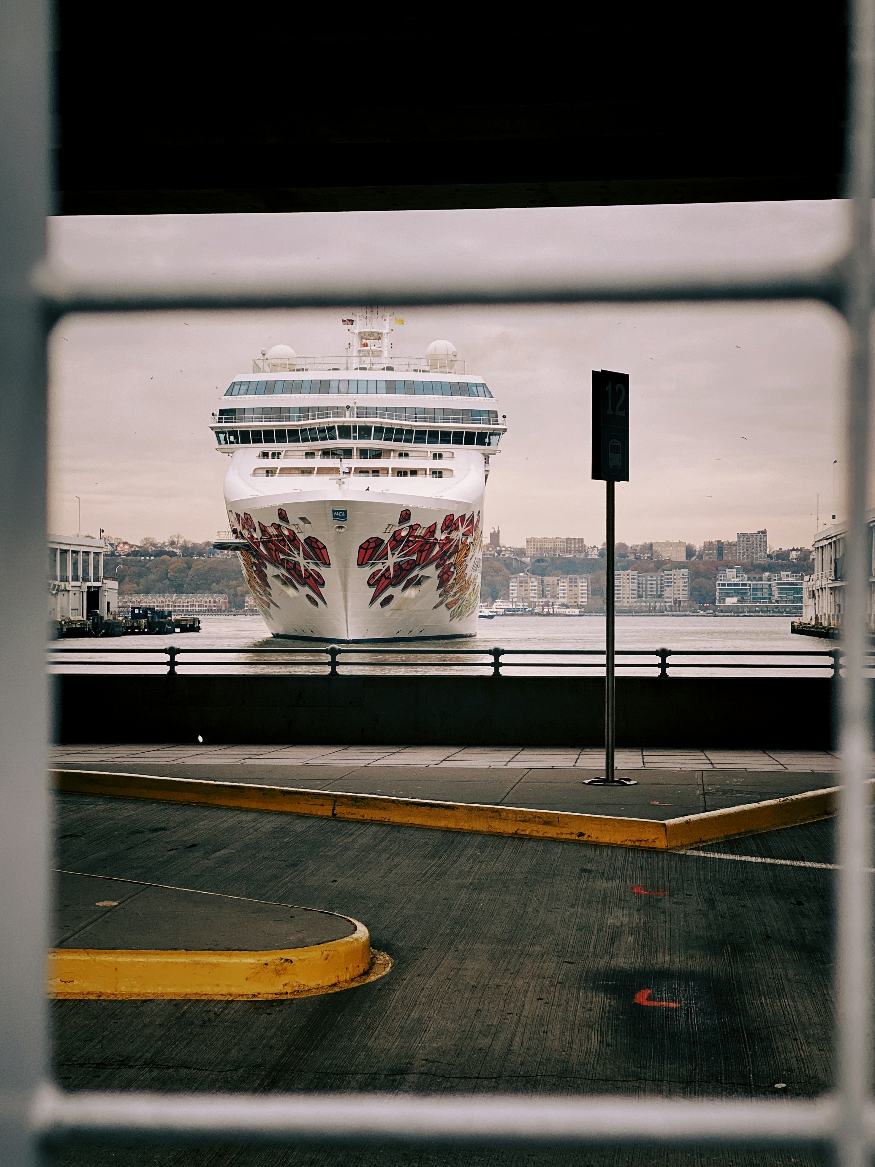 white and red cruise ship beside dock