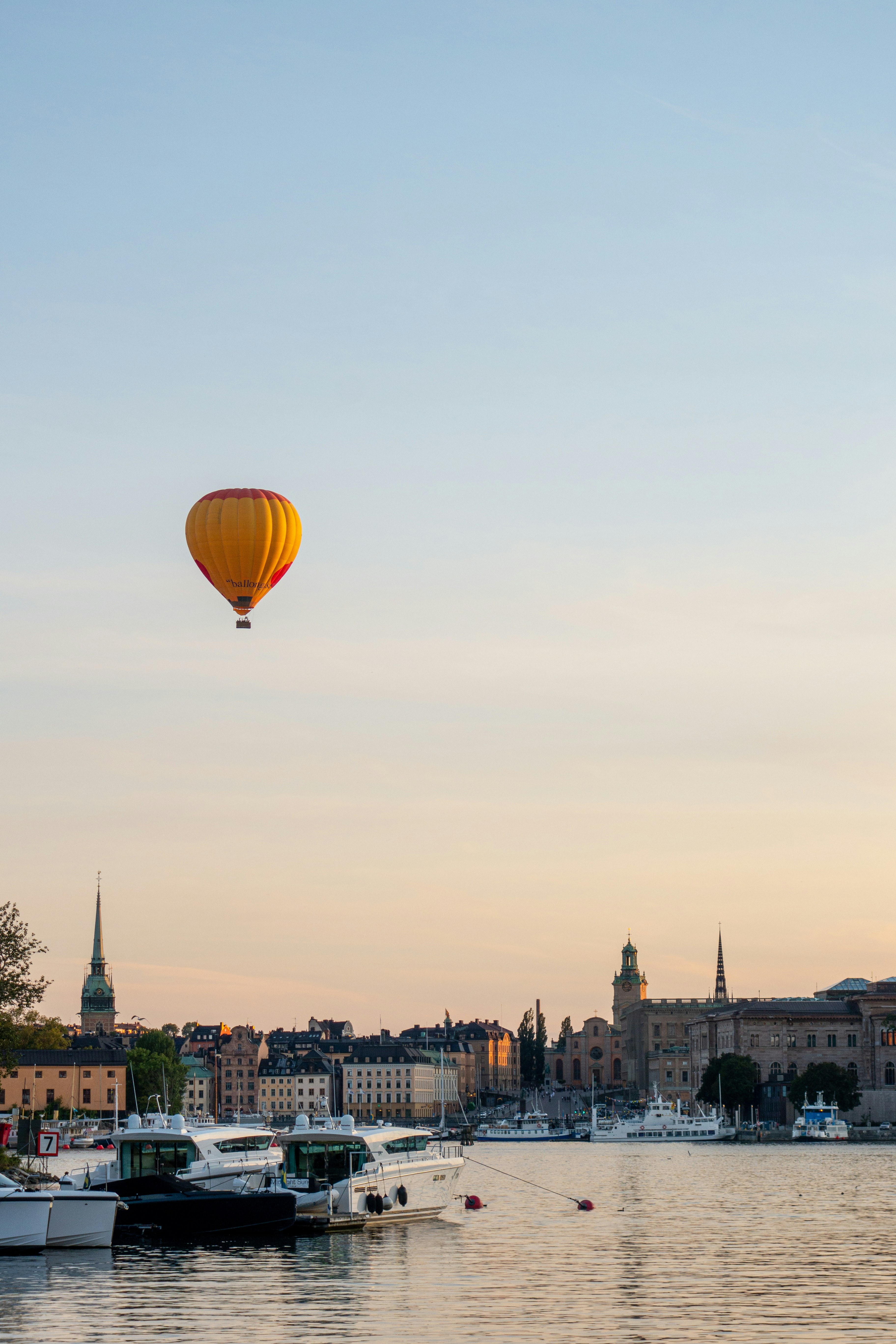 Stockholm summer sunset with hot air ballon in sky | hot air baloon over town
