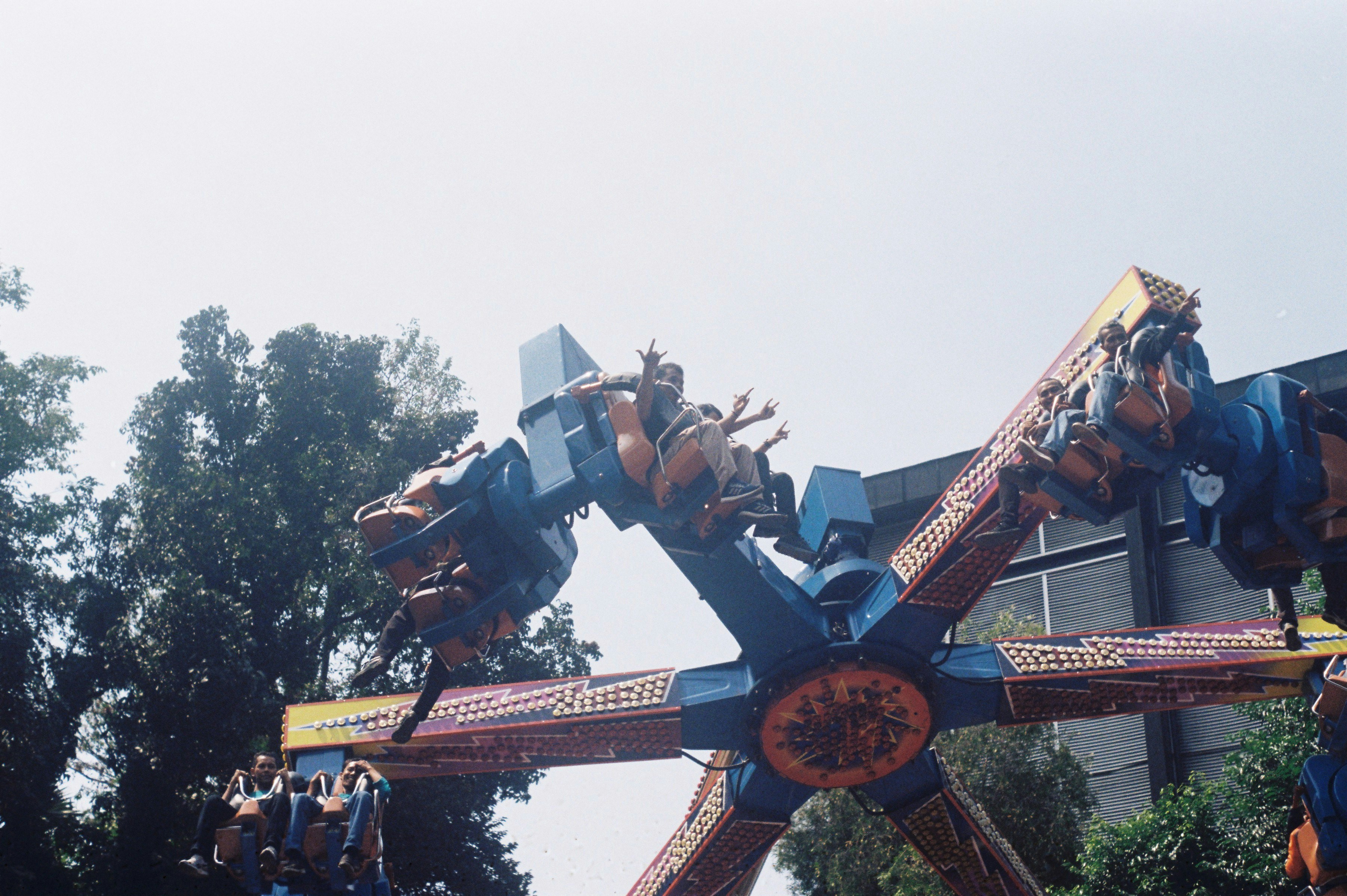Spin of the Starfall: Blue-and-Orange Carnival Ride in Motion