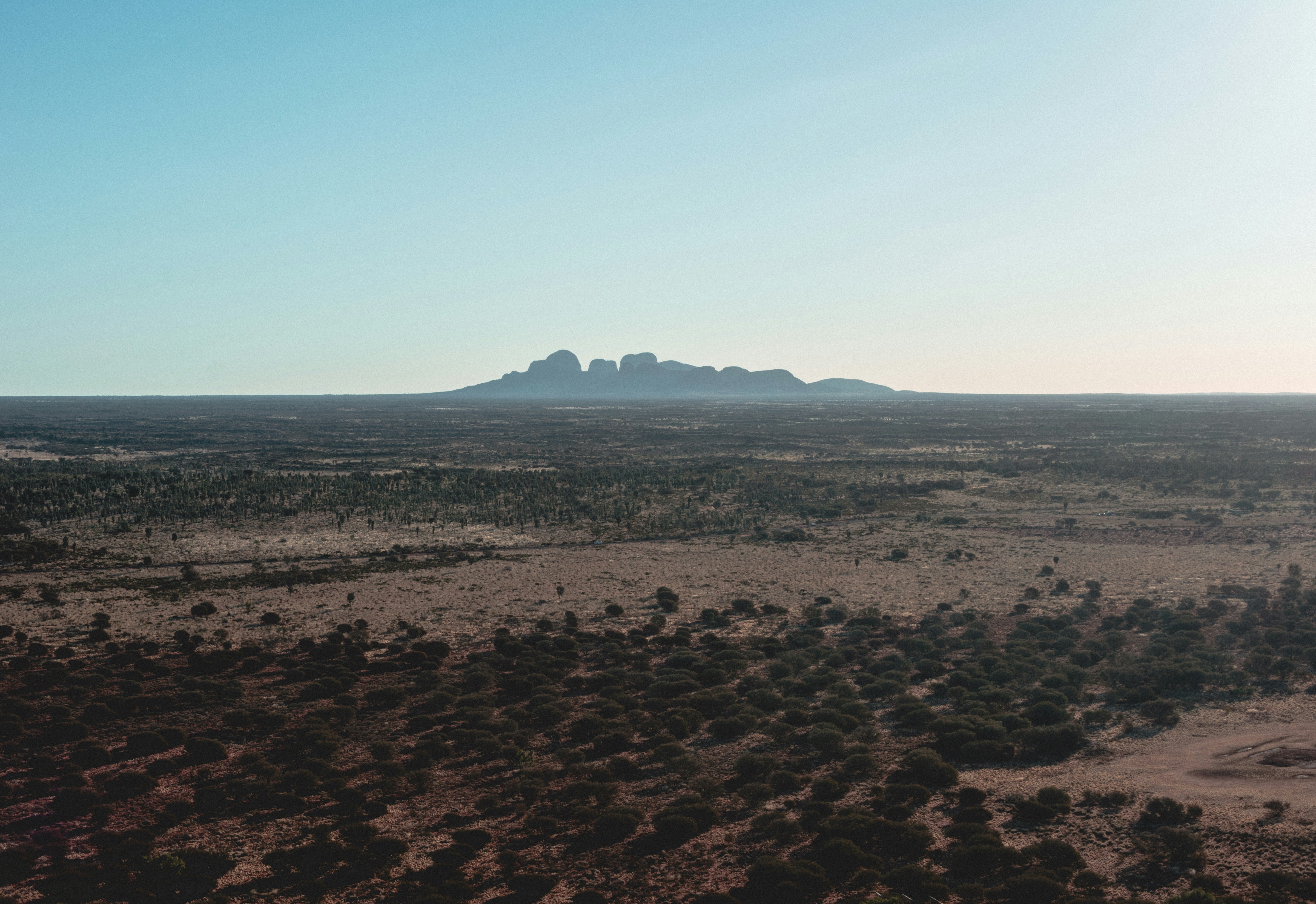 Distant Mesa Crown Over a Sparse Desert Plain