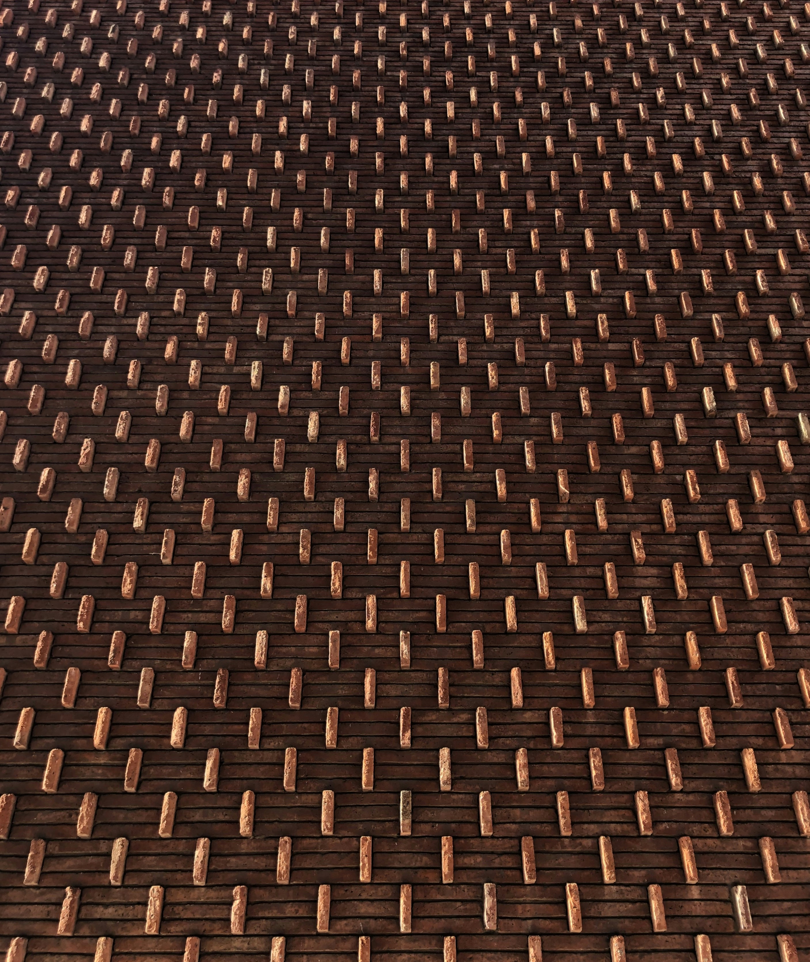 A red stop sign sitting on the side of a brick wall photo – Free ...