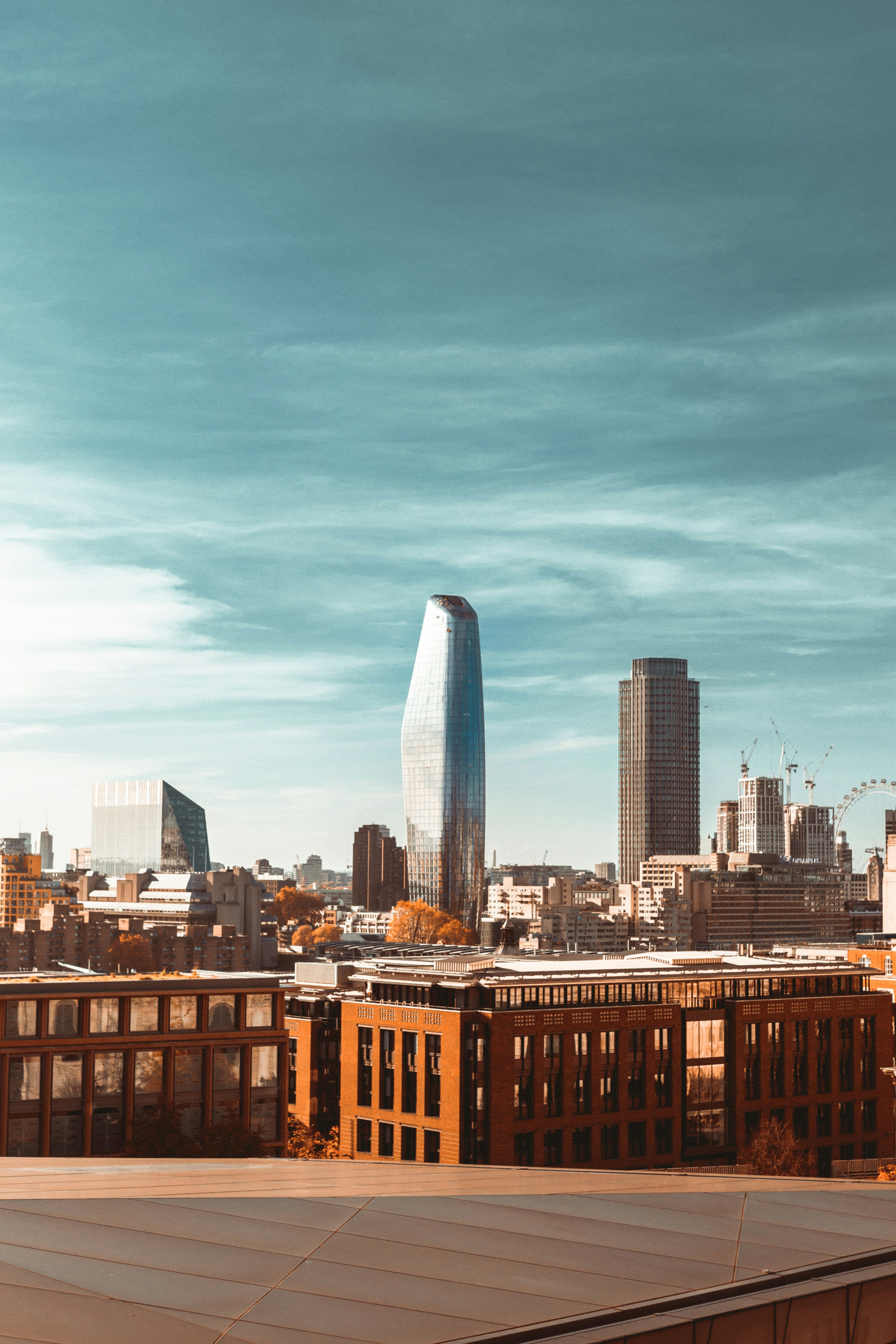 Azure Spire Rises Over a Brick-Red London Skyline