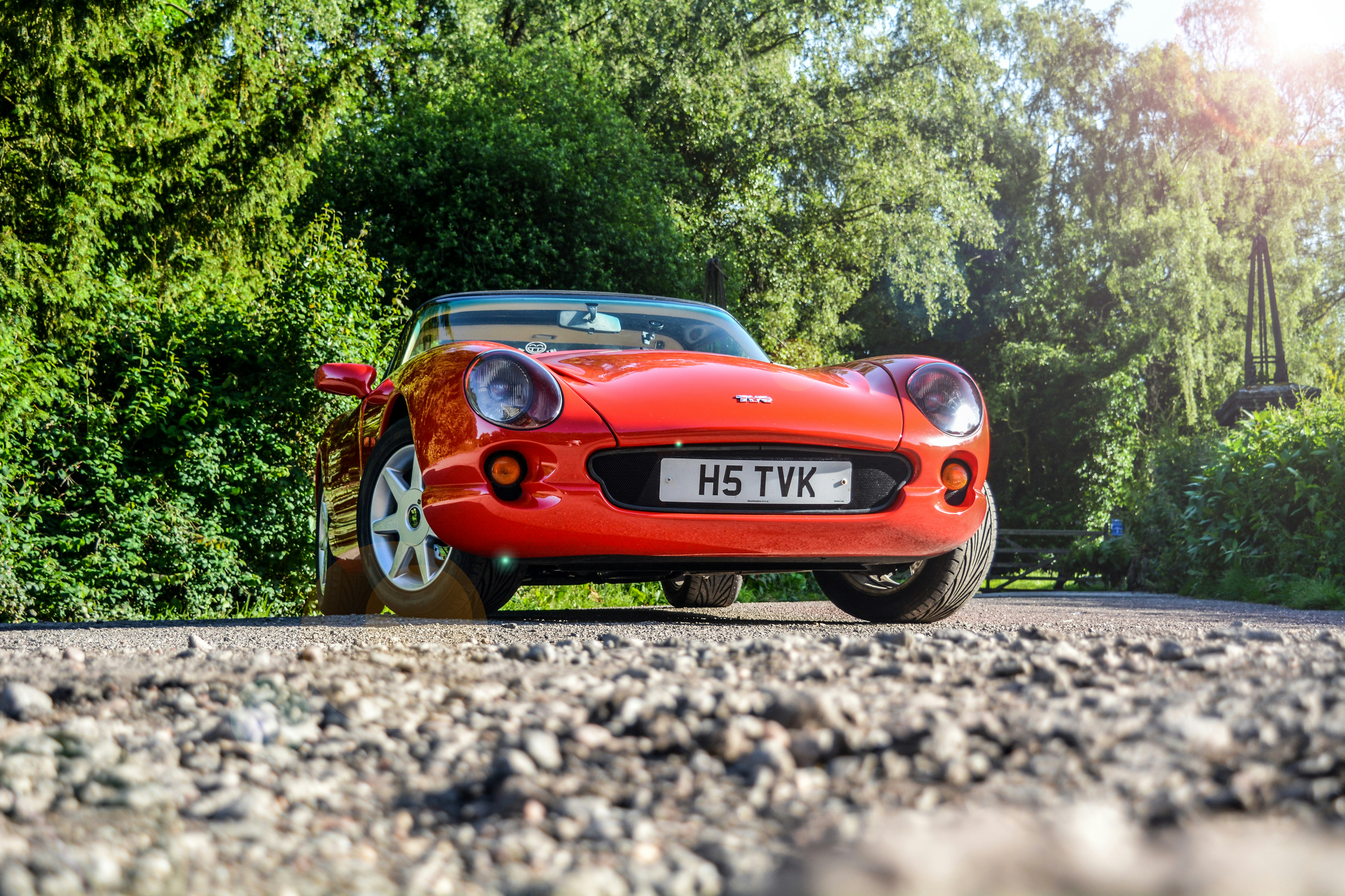 Red vehicle near tree photo – Free United kingdom Image on Unsplash