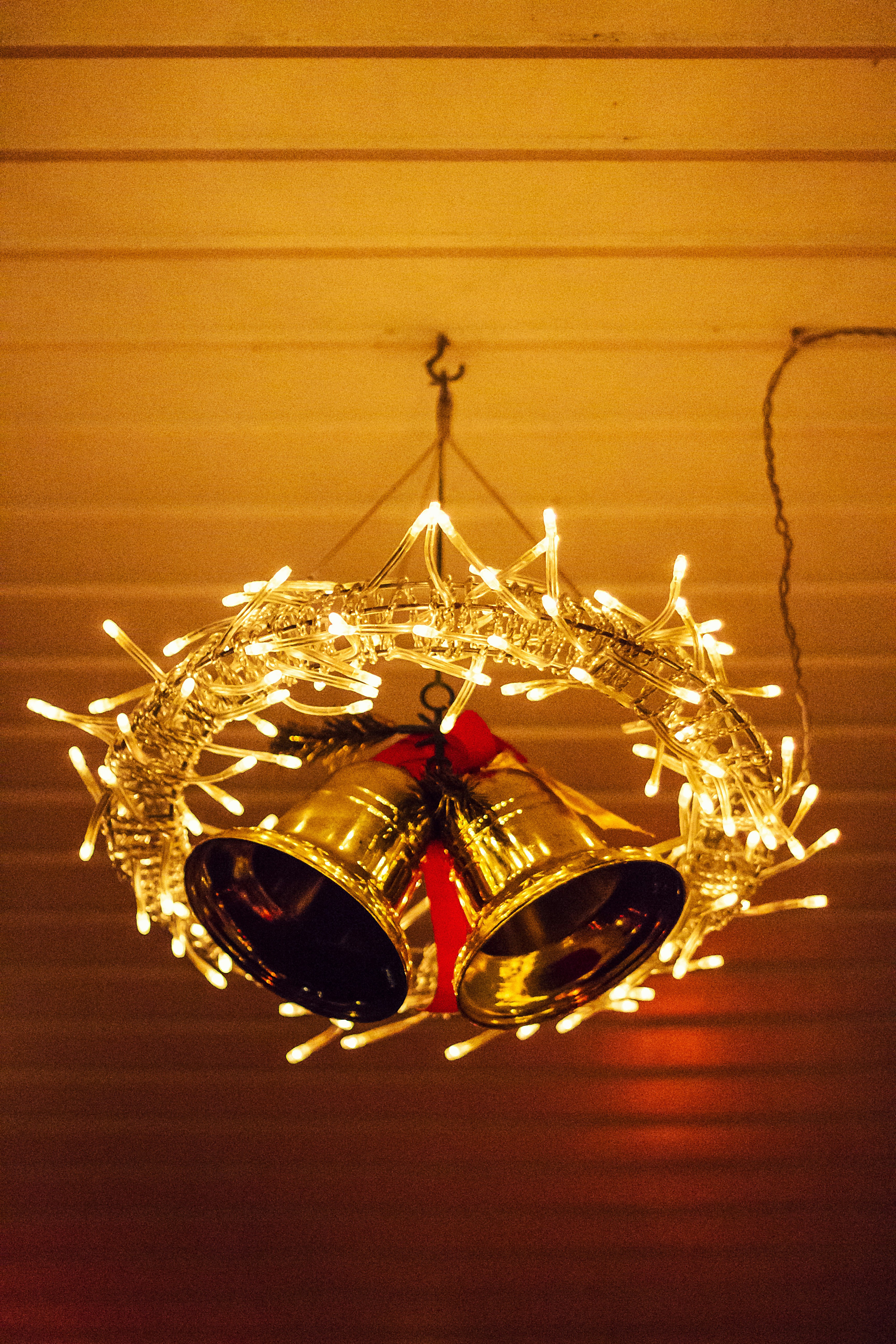 Glowing Bell Duo: A Festive Ring of Lights Cradling Shiny Bells