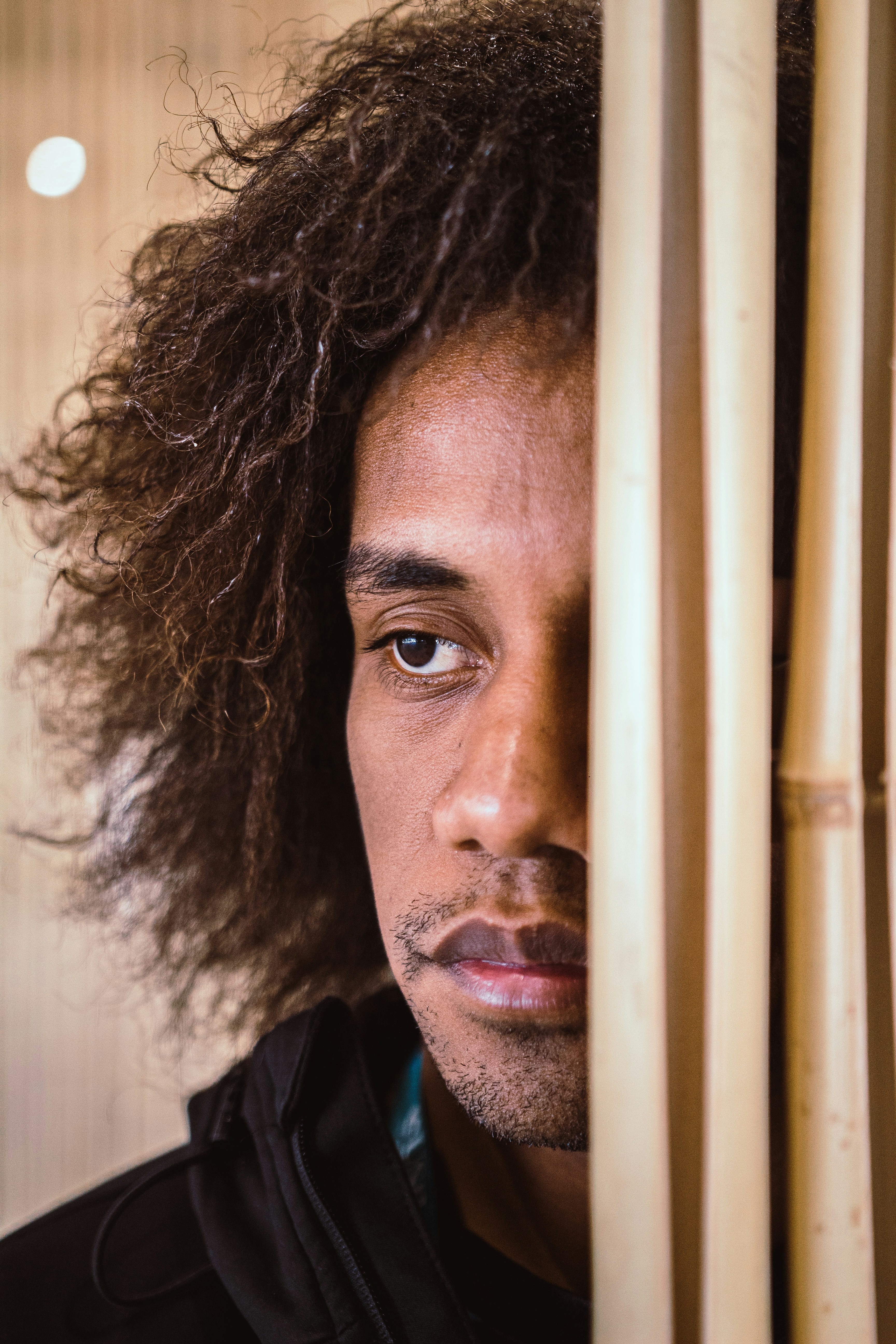 Half-Visible Portrait Through Bamboo Bars