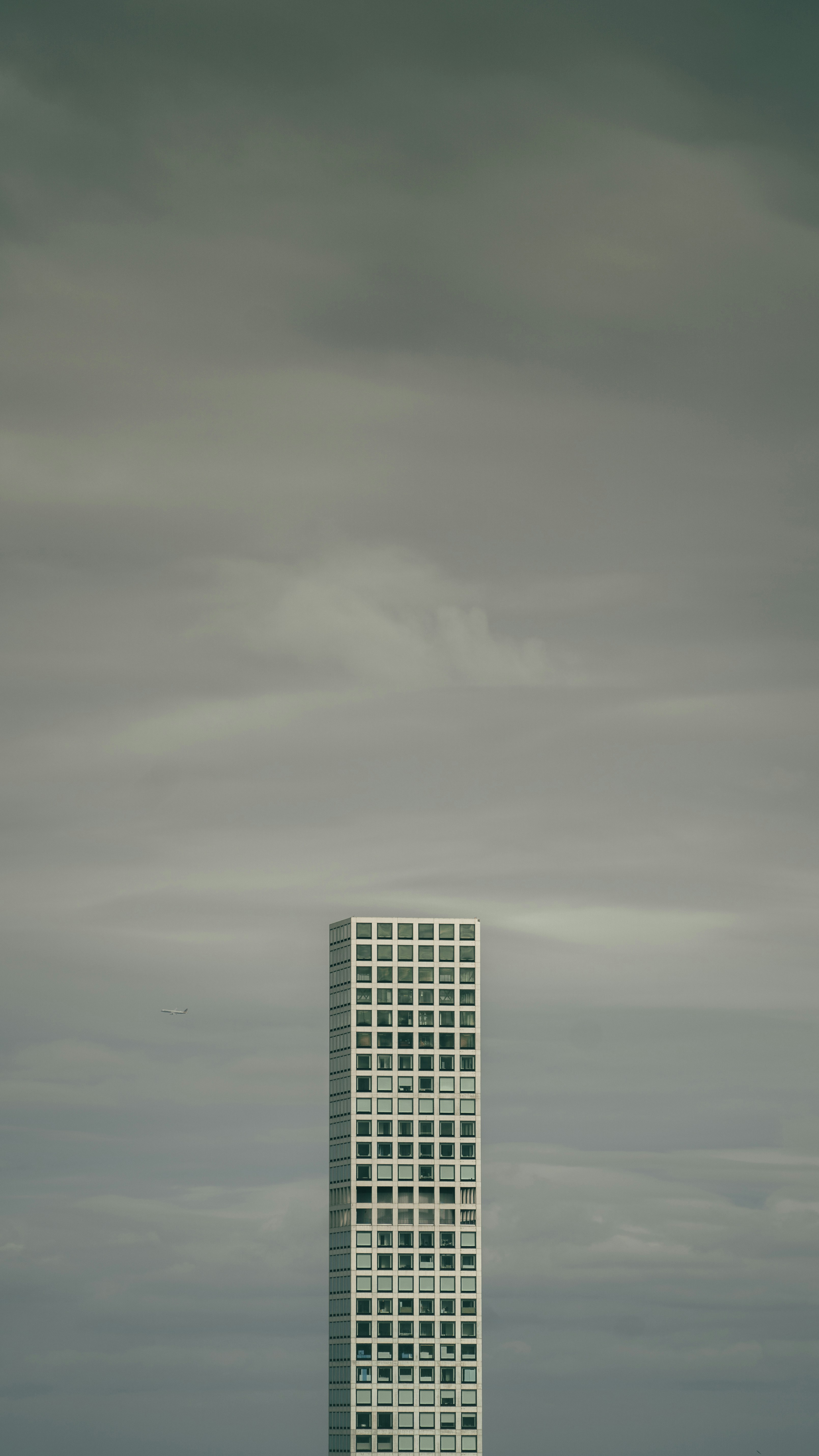 gray high-rise building under cloudy sky during daytime