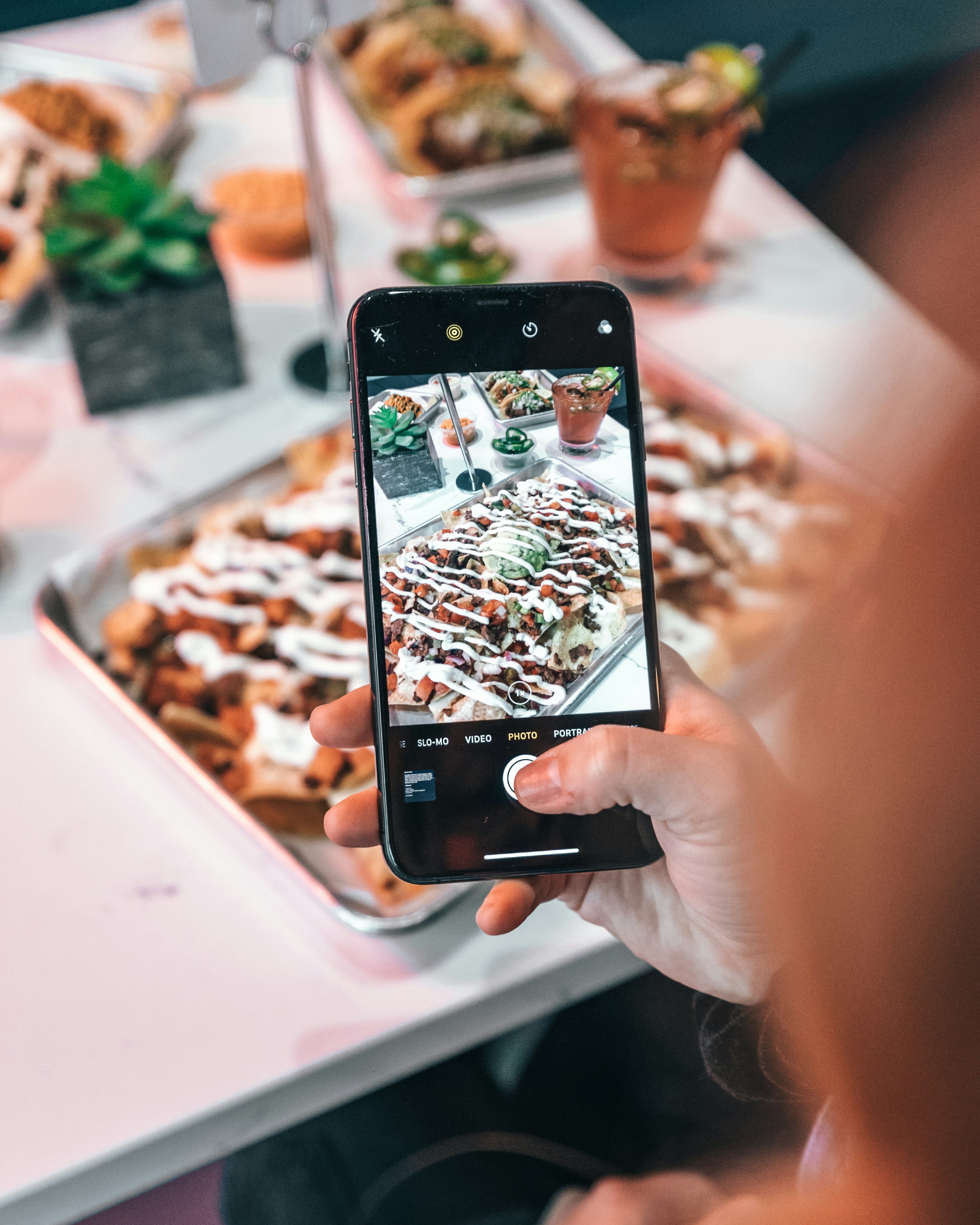 Smartphone Snapshot of a Dessert Feast: Hands, Screen, and Drizzled Treats