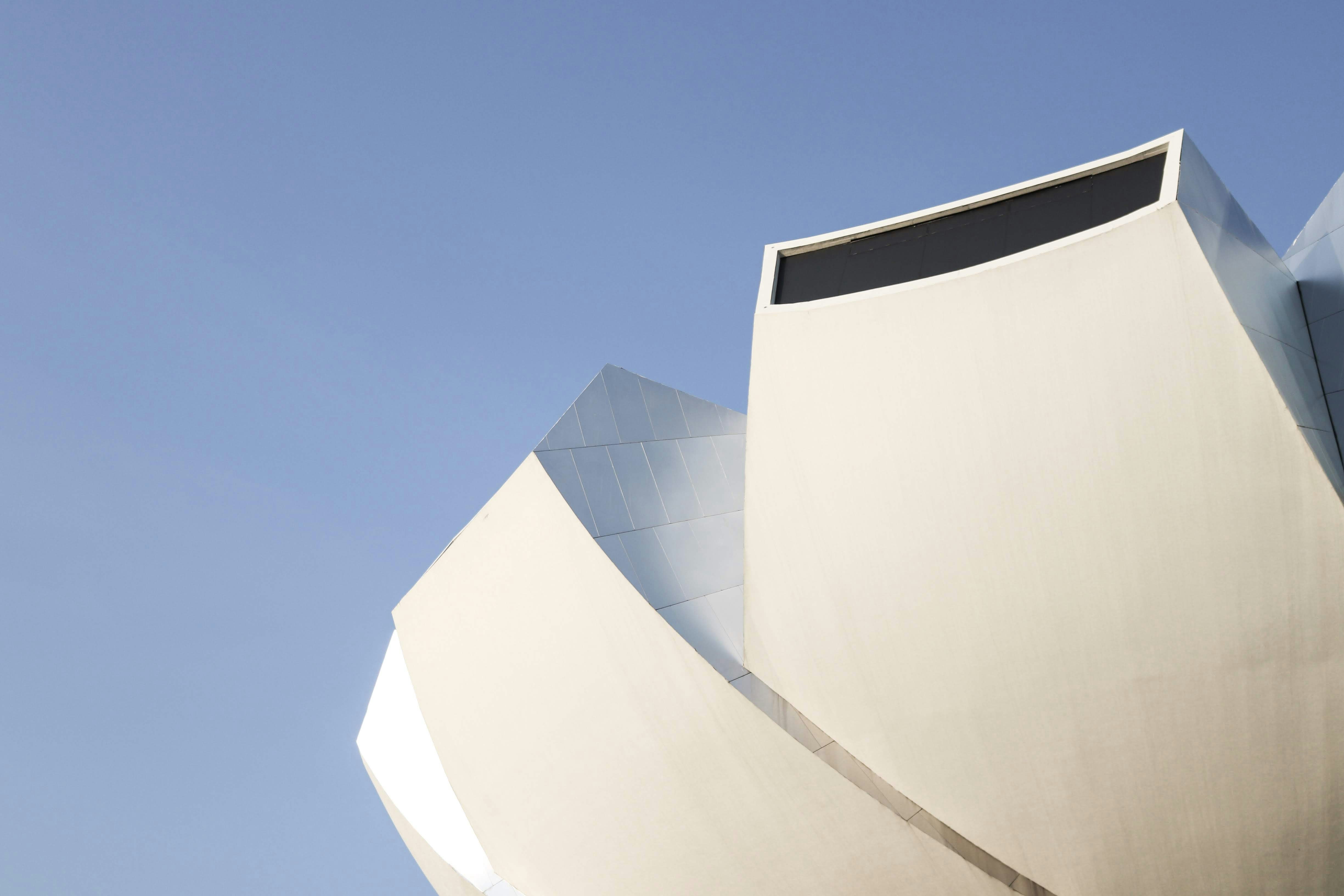 Low-angle photography of white dome building under a calm blue sky ...