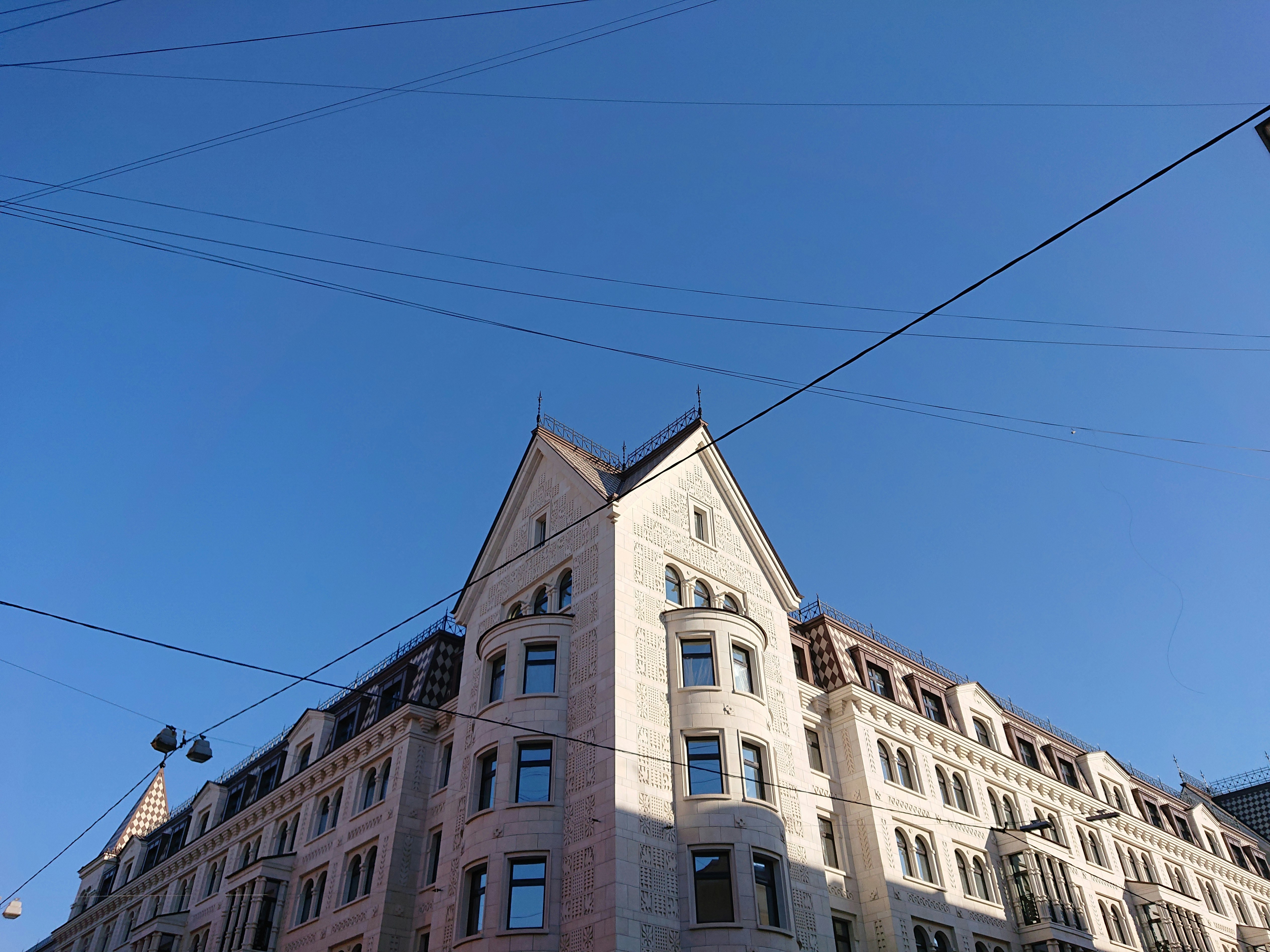 Historic building with a triangular peak set against a vivid blue sky.