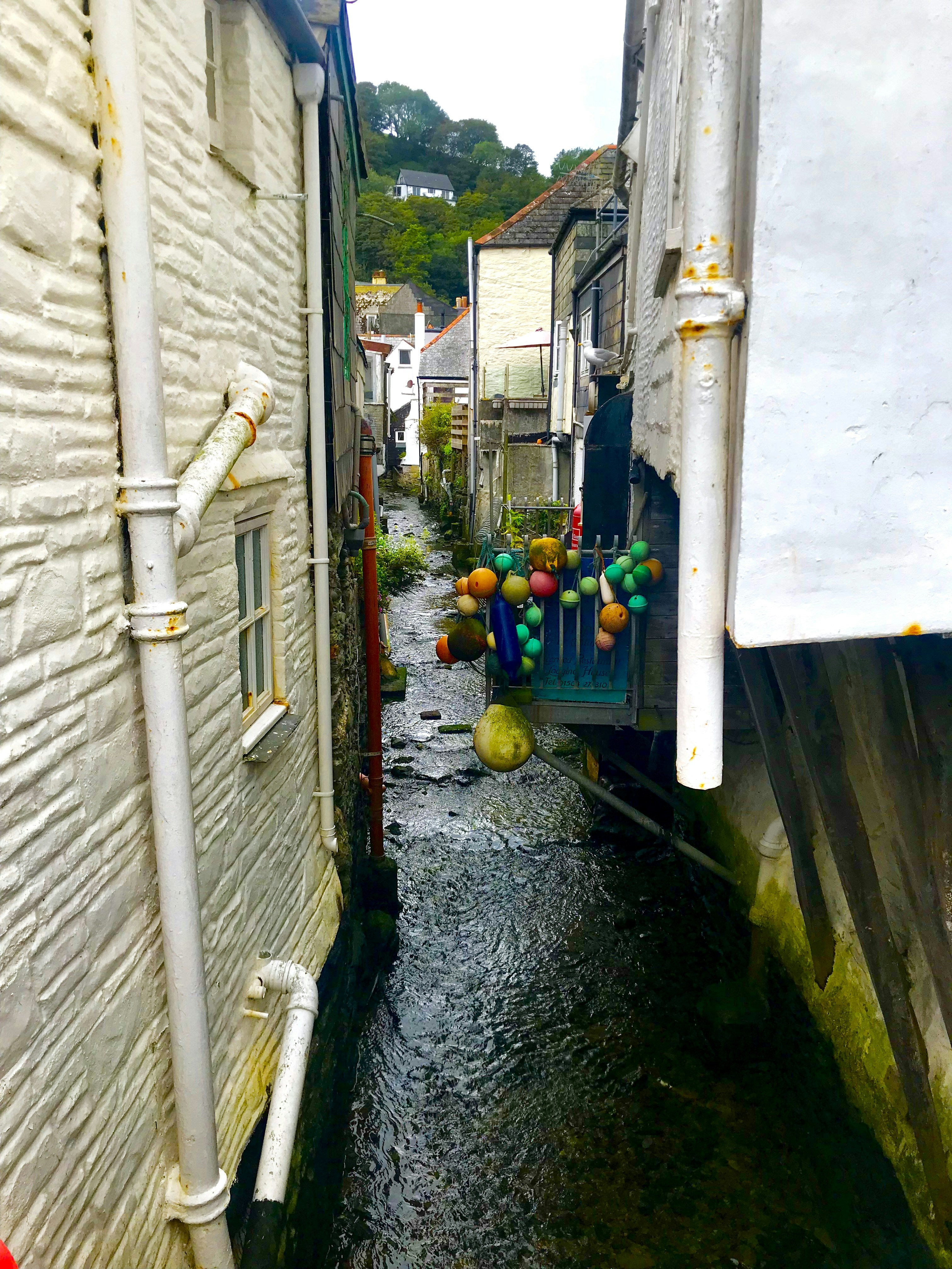 Orbs on a Narrow Canal Alley: A Burst of Color by the Waterway