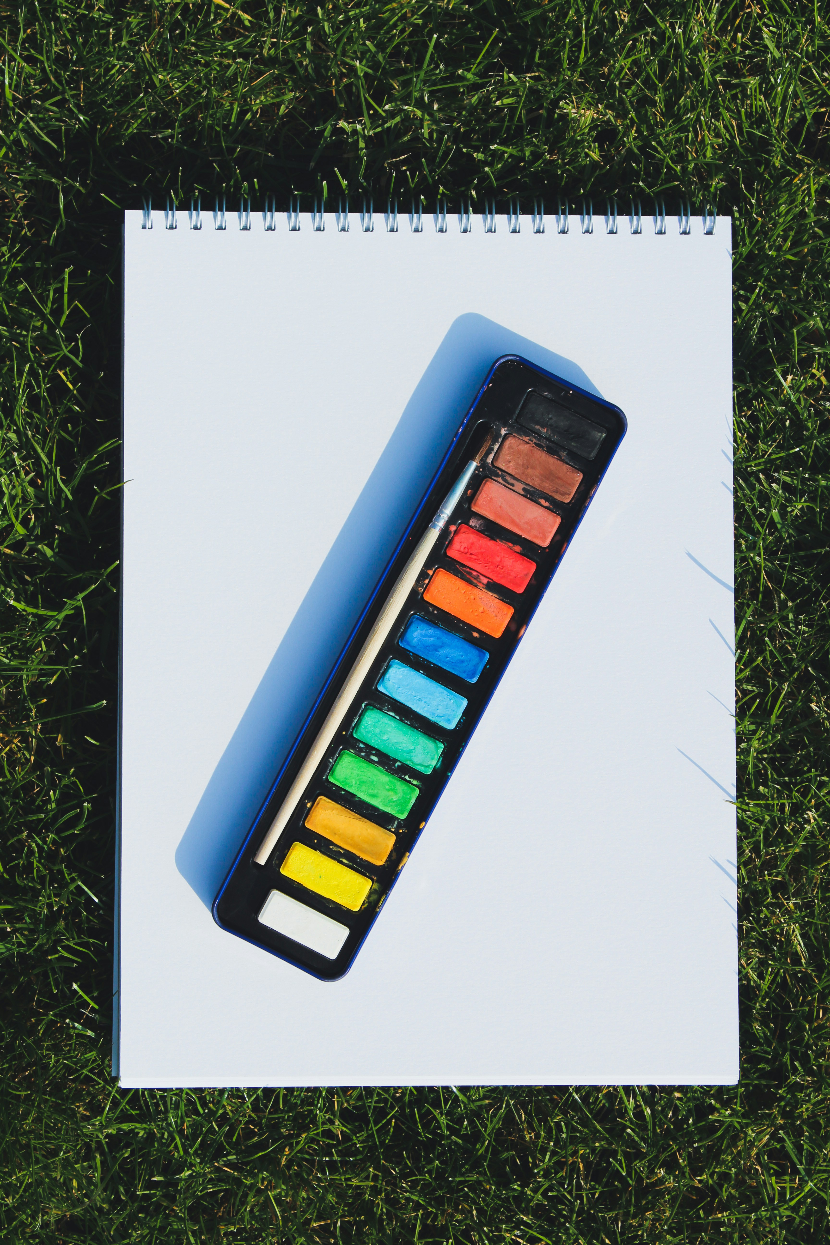 Diagonal Rainbow: Watercolor Palette on a White Notebook