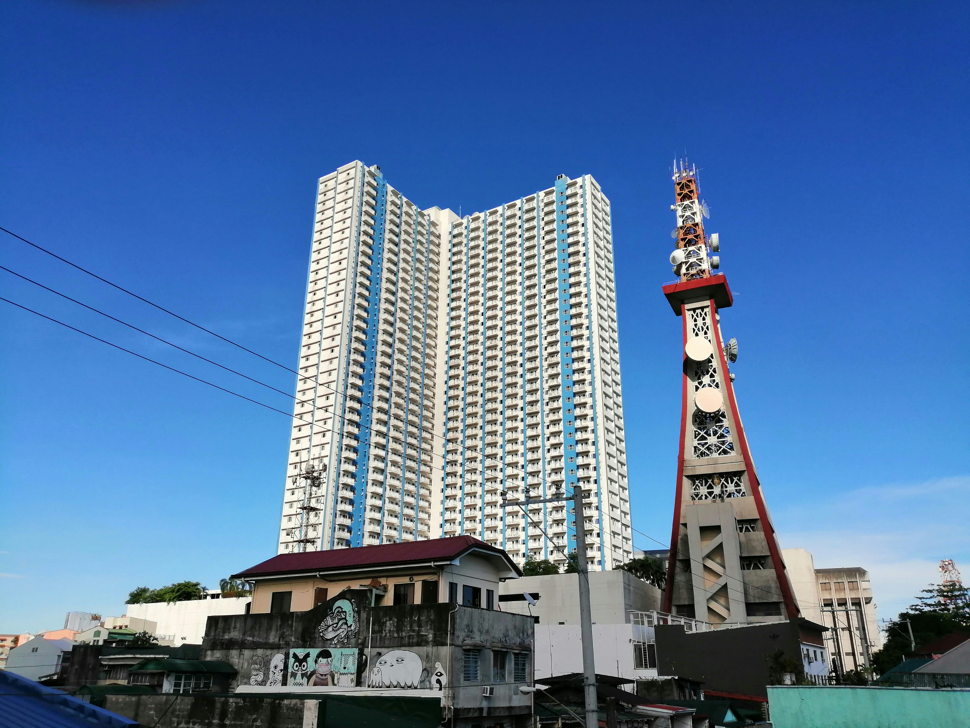 Gray concrete high-rise building near gray tower photo – Free Building ...