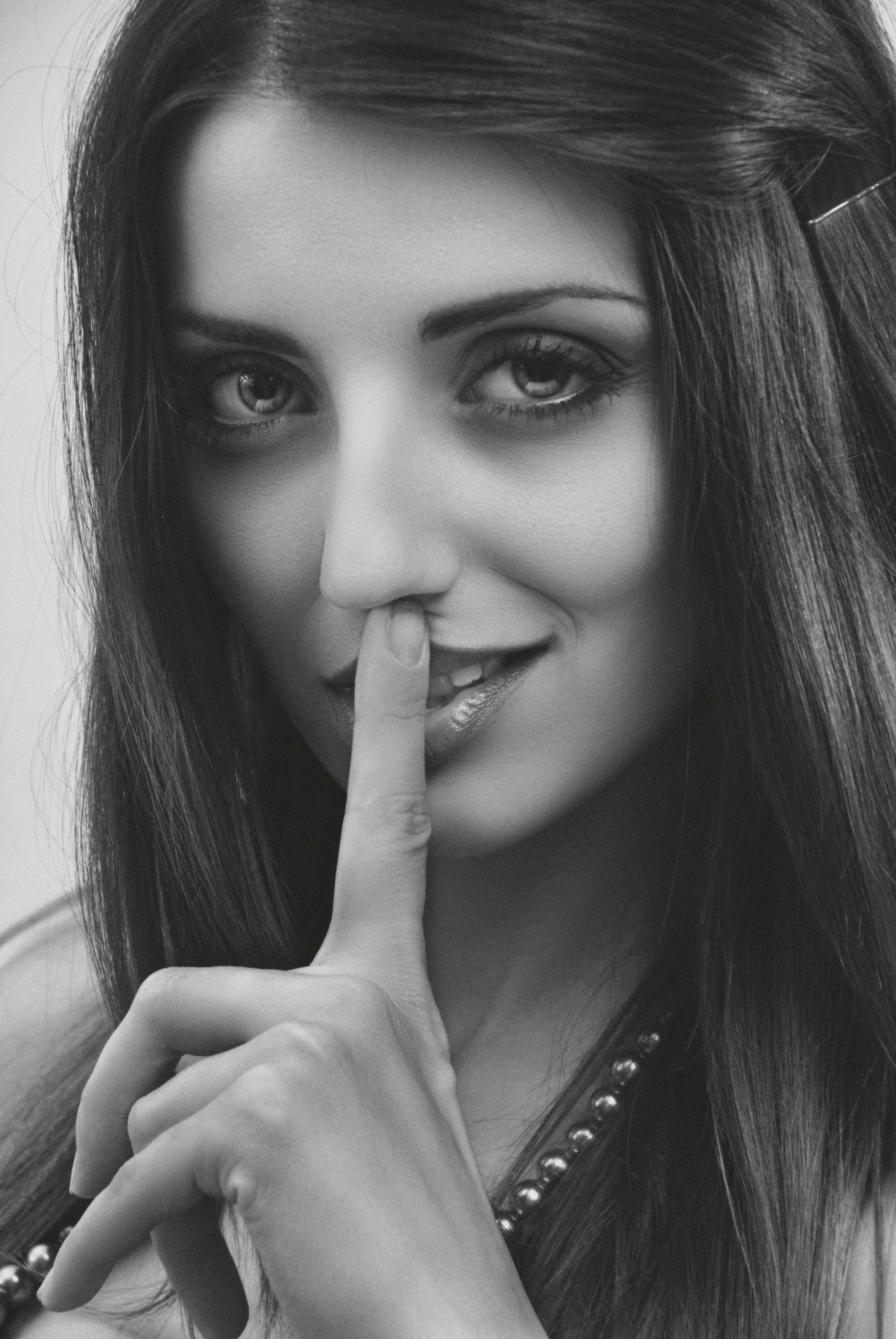 A woman making a hush with her finger photo – Free Portrait Image on ...