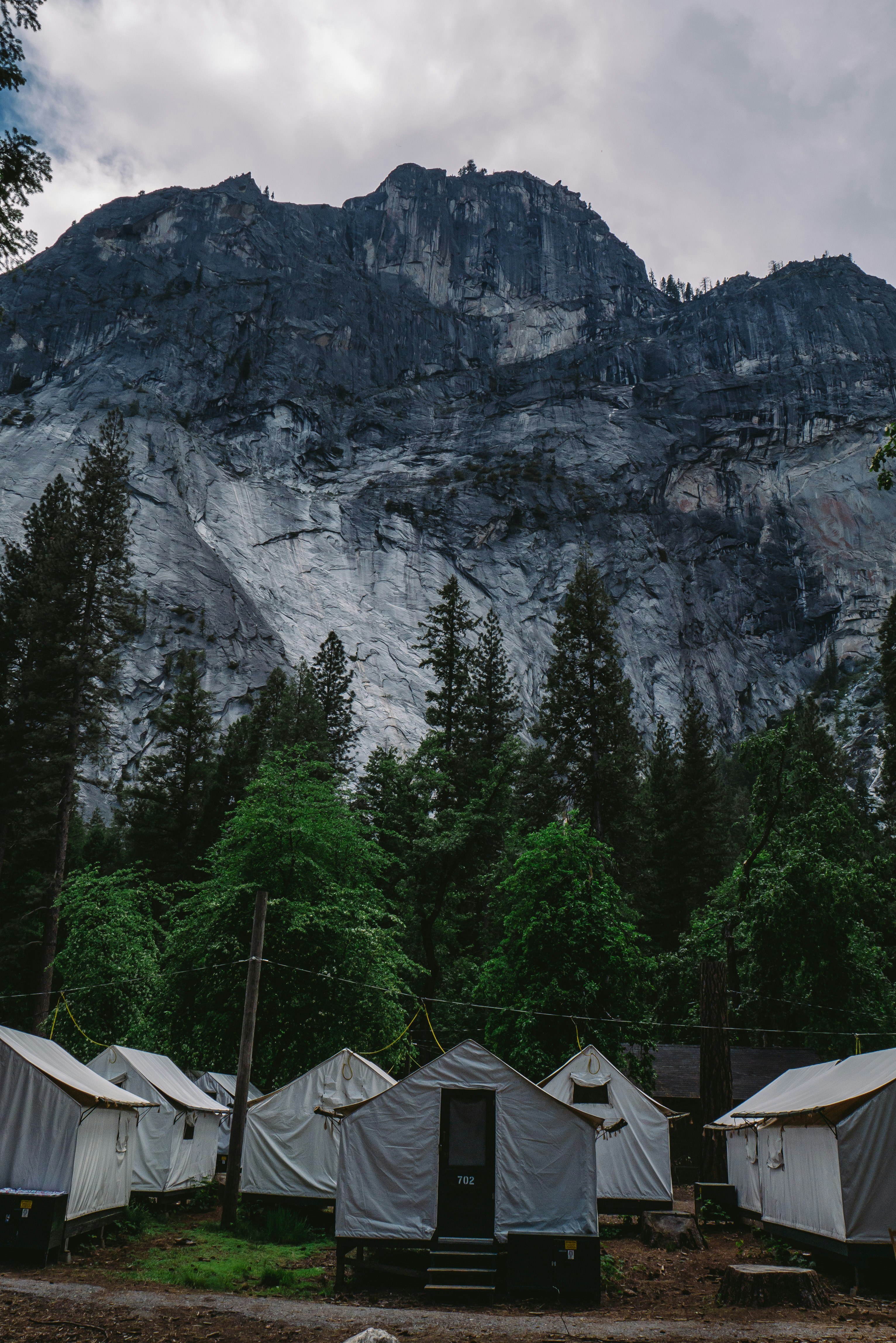 Whispers of Nature: Tents Beneath Majestic Cliffs
