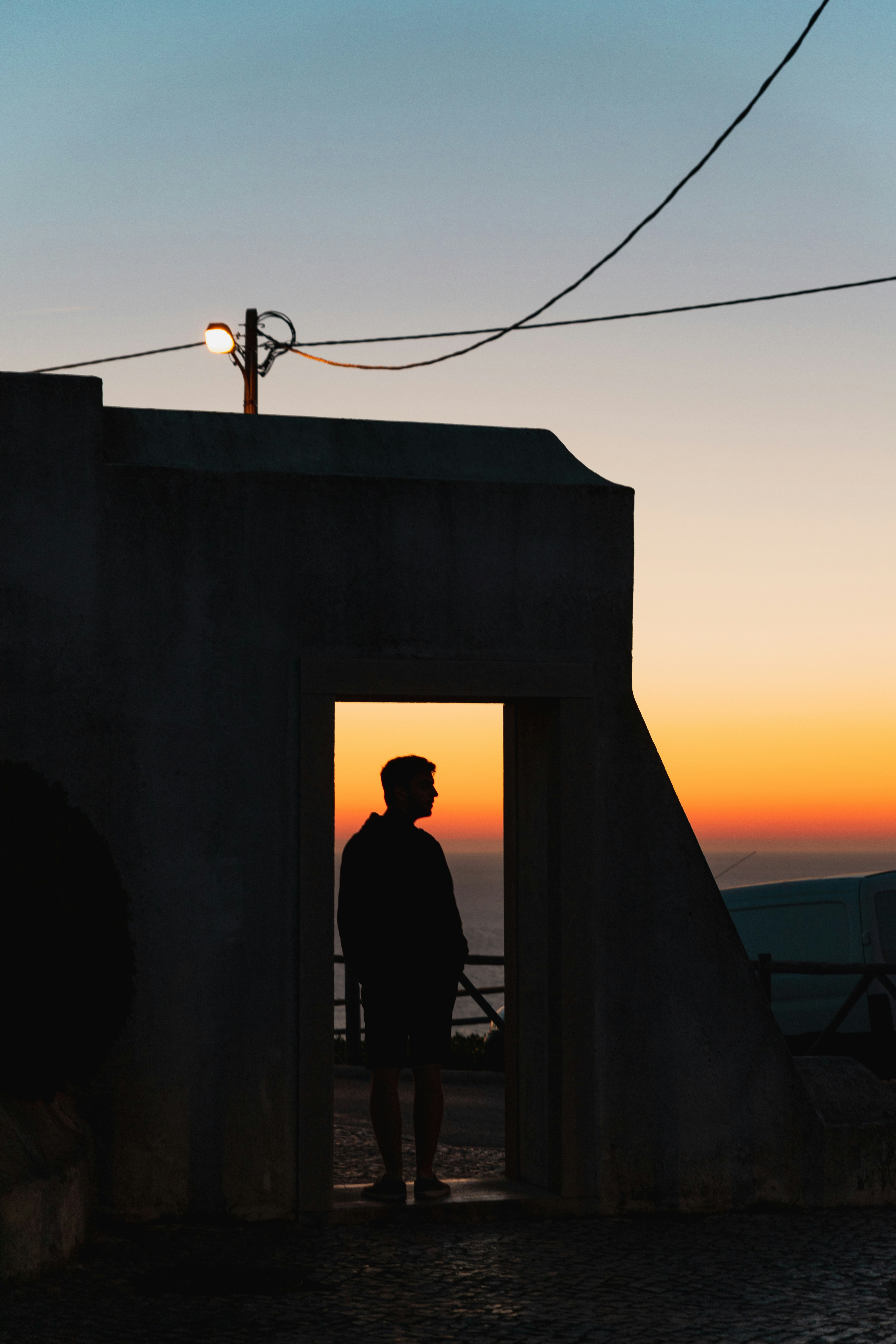 Threshold at Dusk: A Lone Silhouette Framed by Sunset