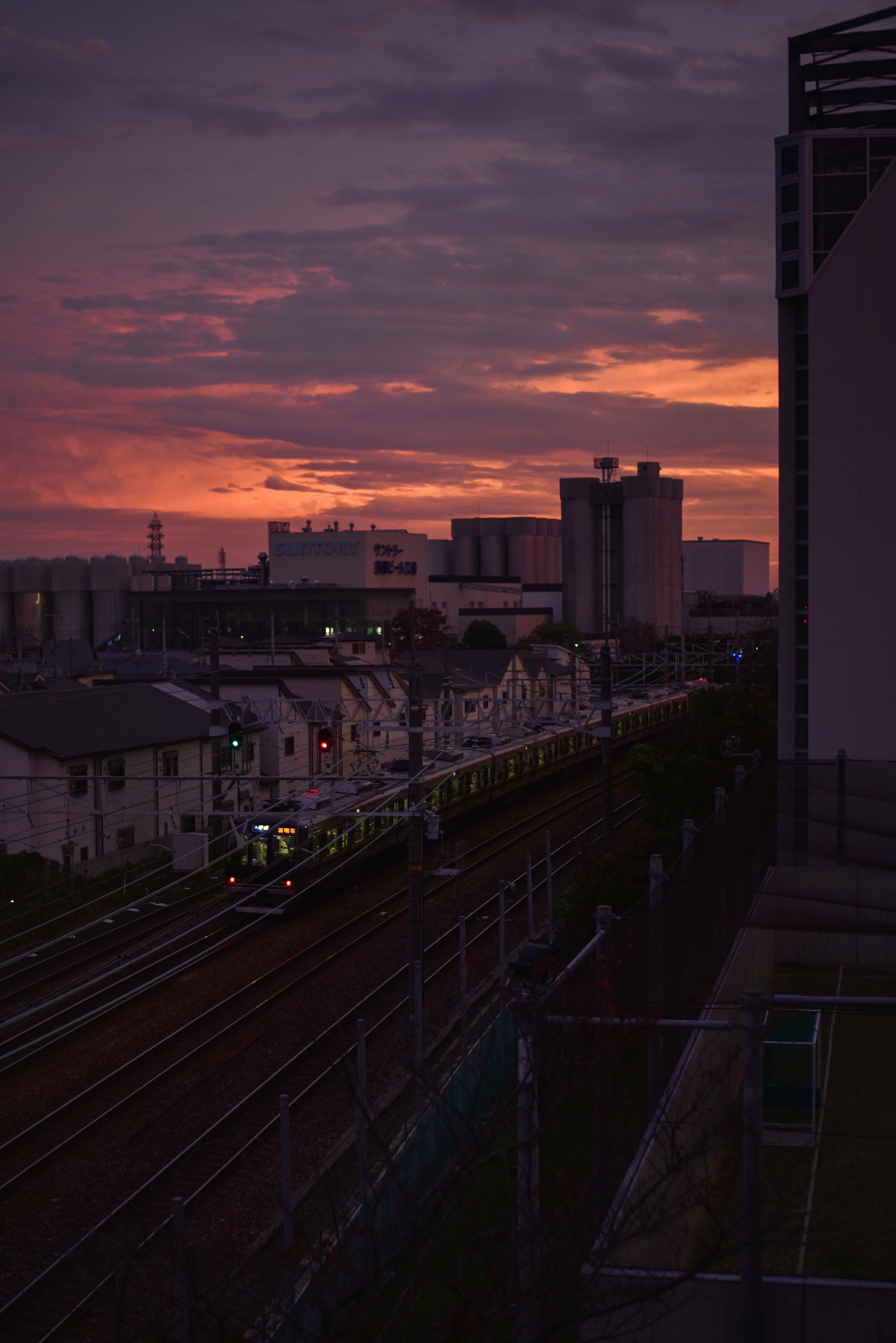 Twilight Rails Over a Pink-Orange Cityscape