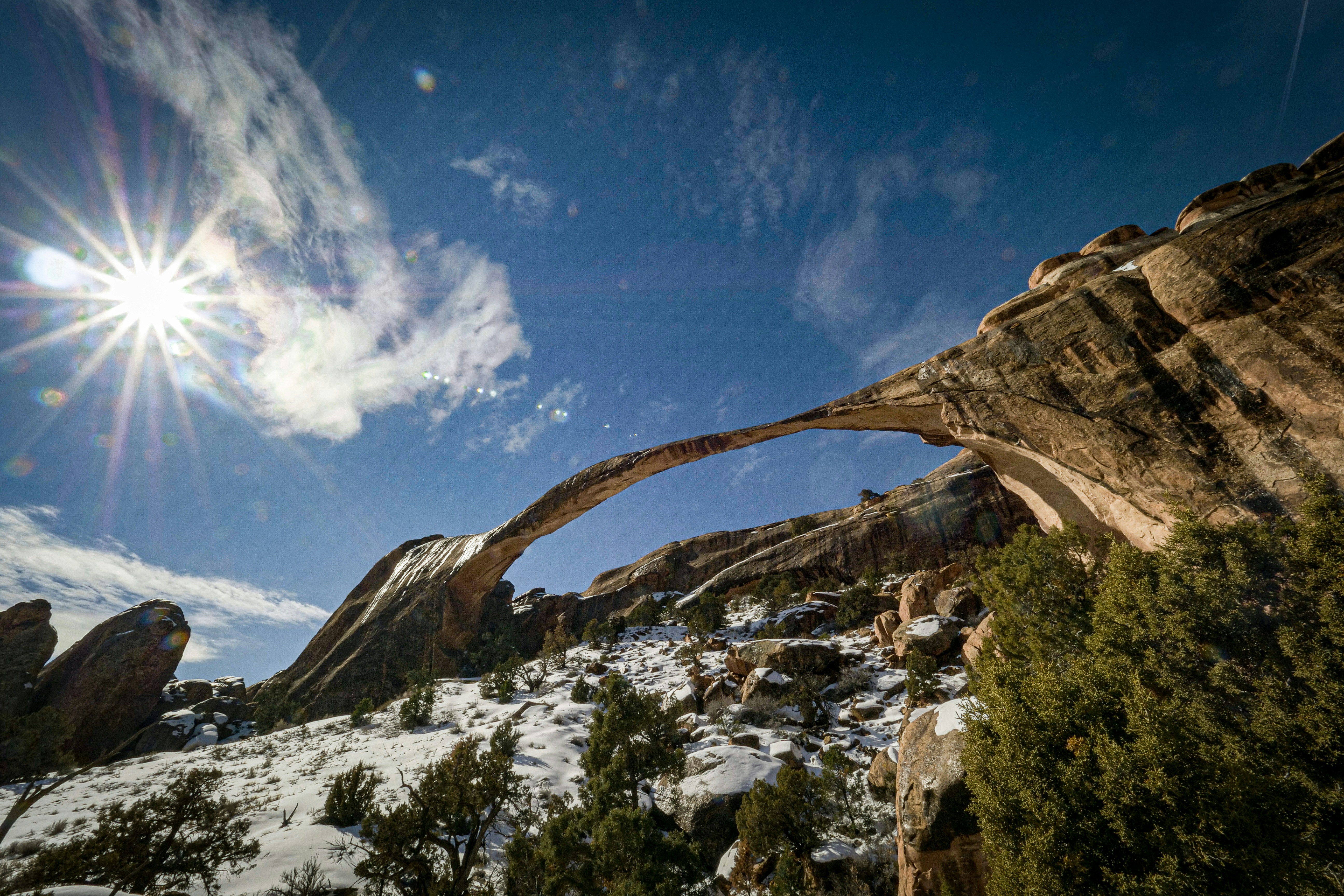 Granite Arch Under a Starburst Sky: Snow-Kissed Terrain