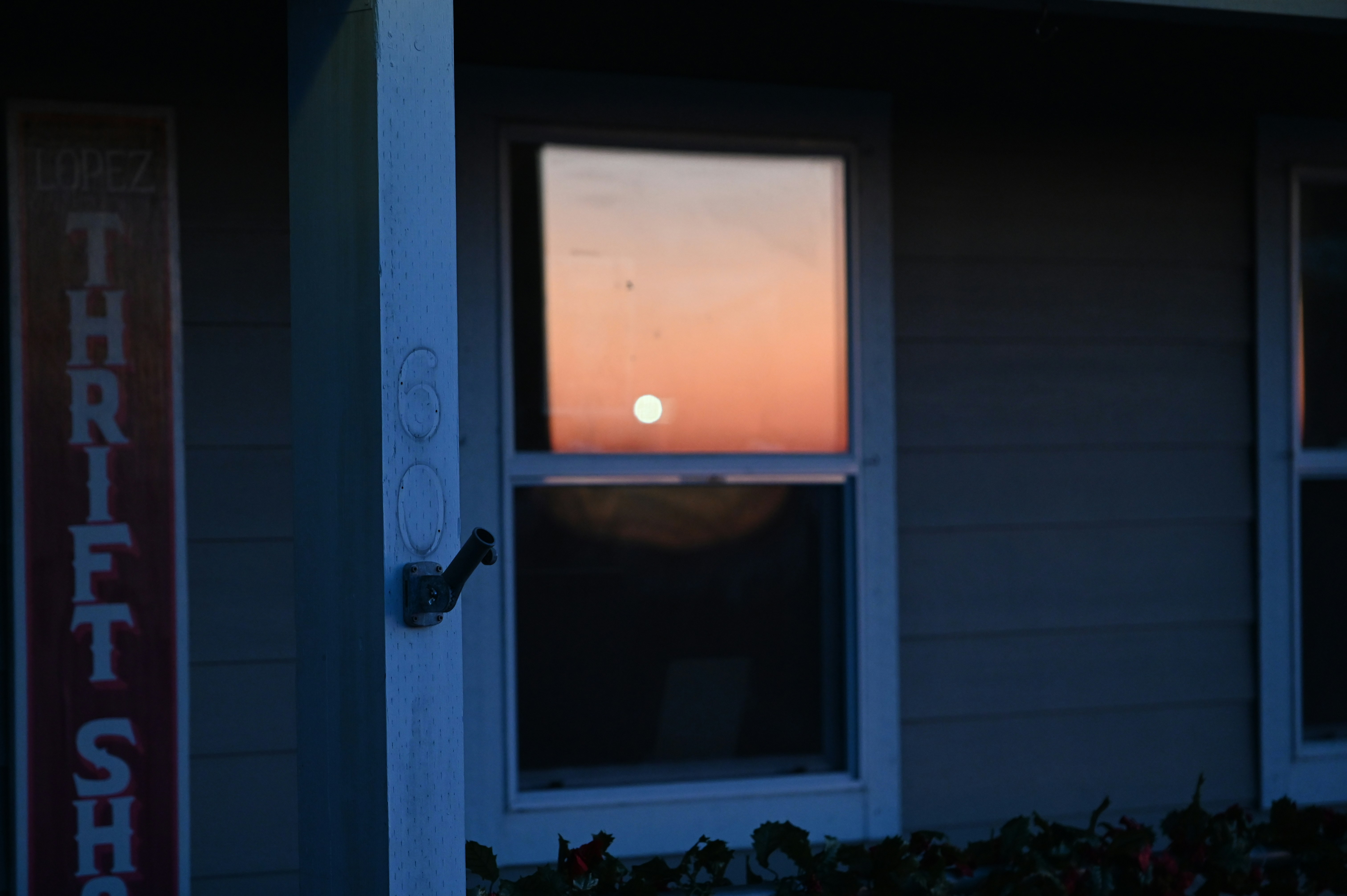 Sunset Reflections Through a Thrift Store Window