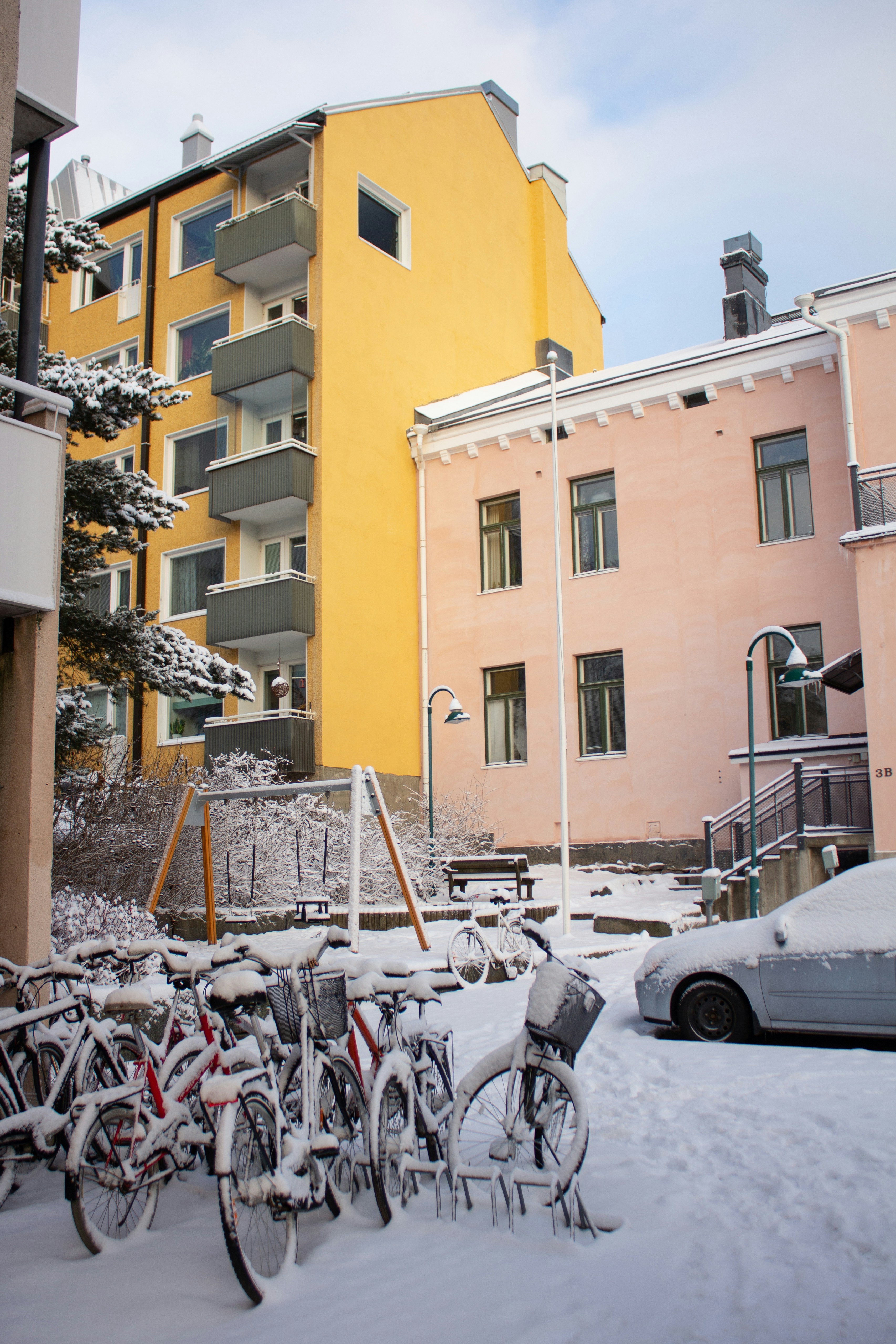 Yellow Apartment Block Overlooking a Snow-Covered Courtyard
