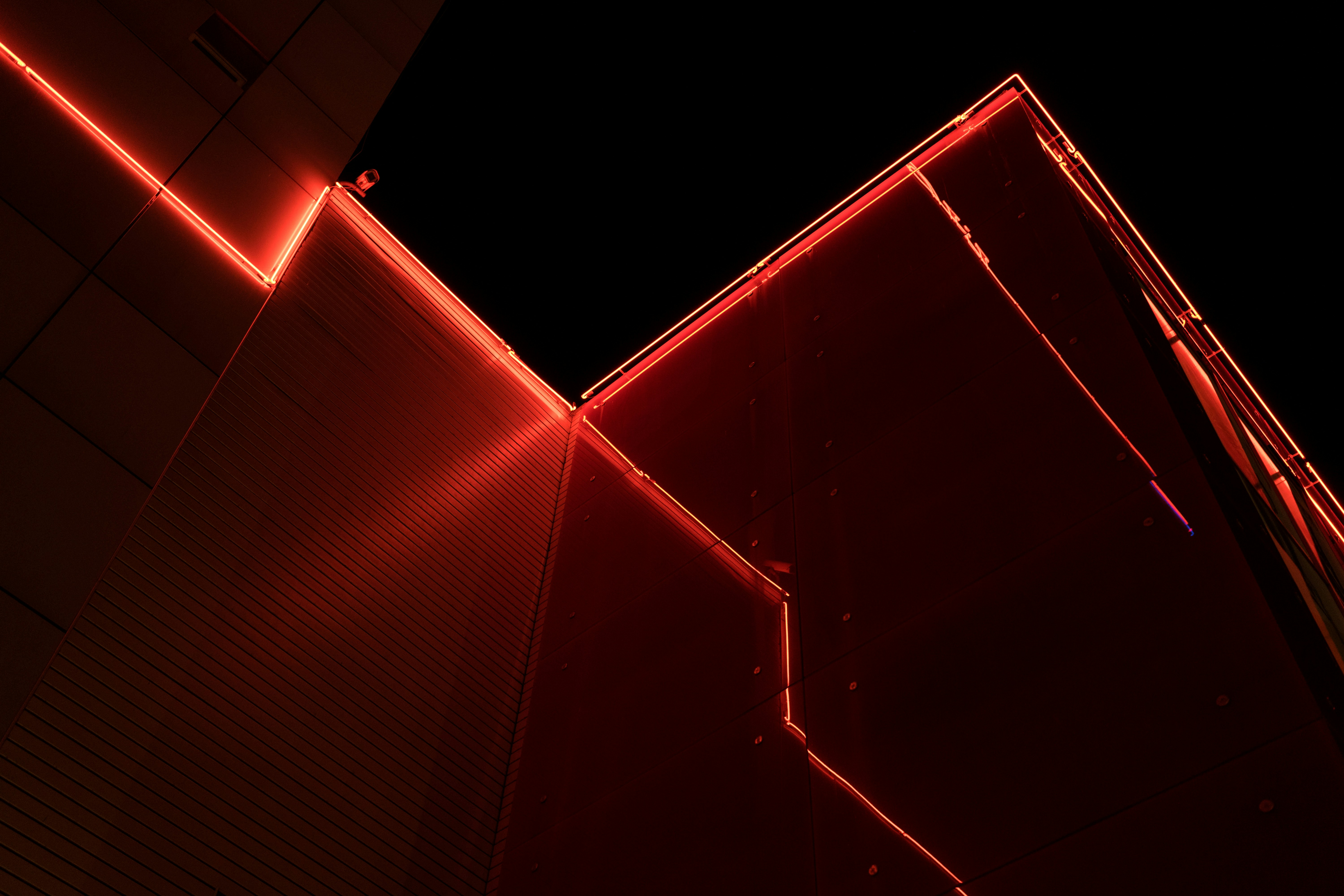 A building with red lights on the side of it photo – Free Light Image ...