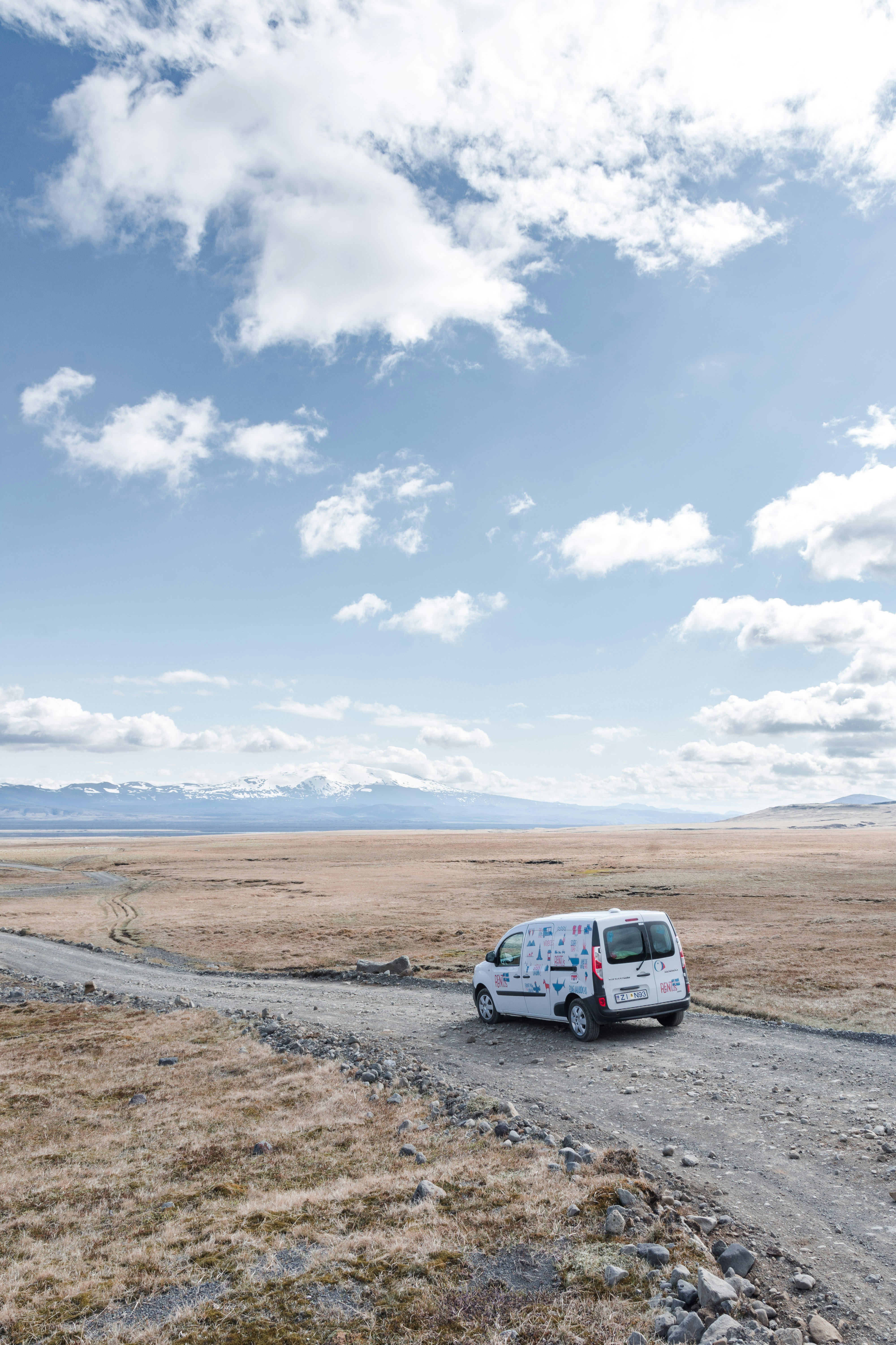Wide Sky, Narrow Road: A White Van on the Distant Plain