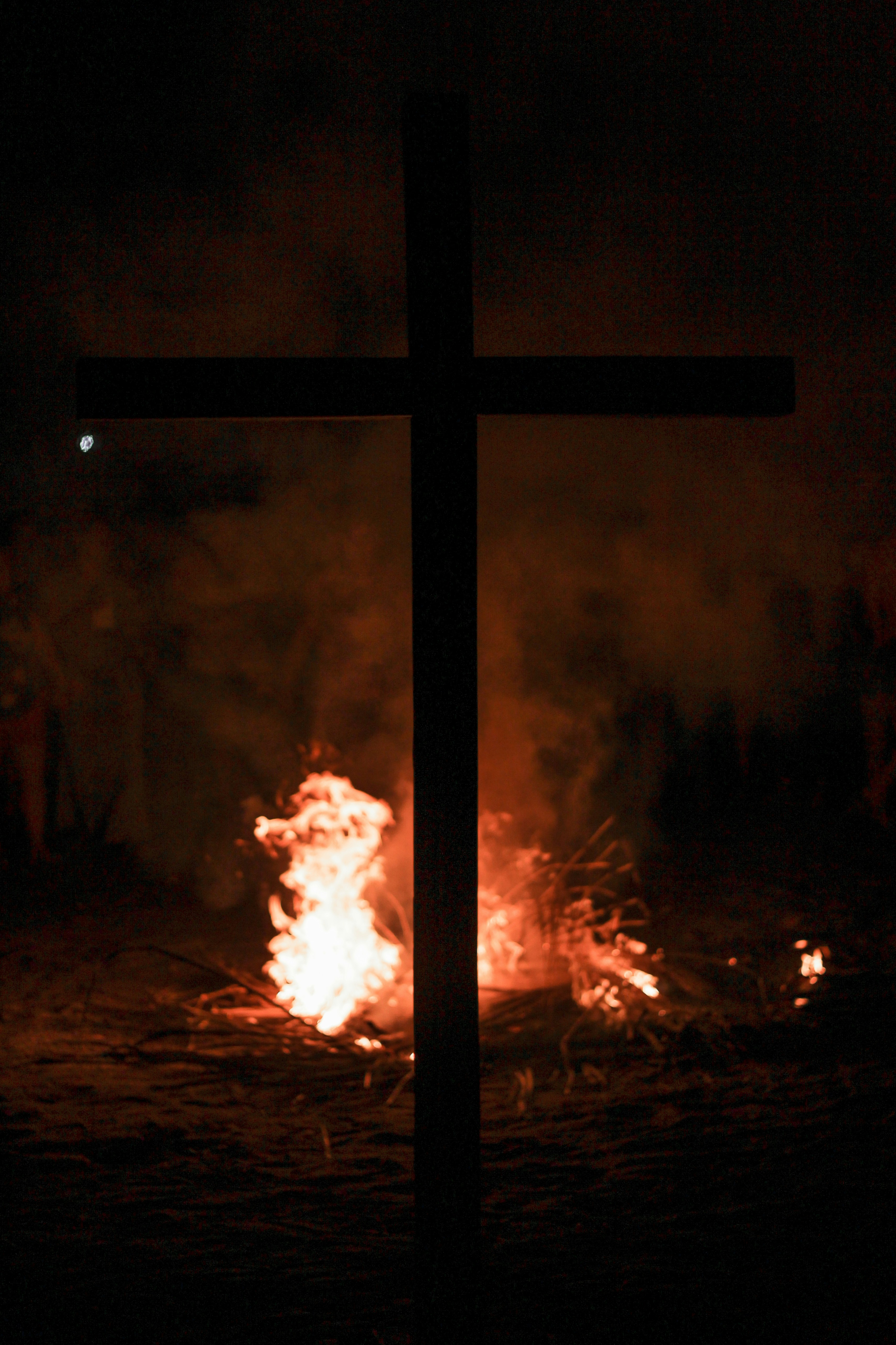 a cross is lit up in the dark