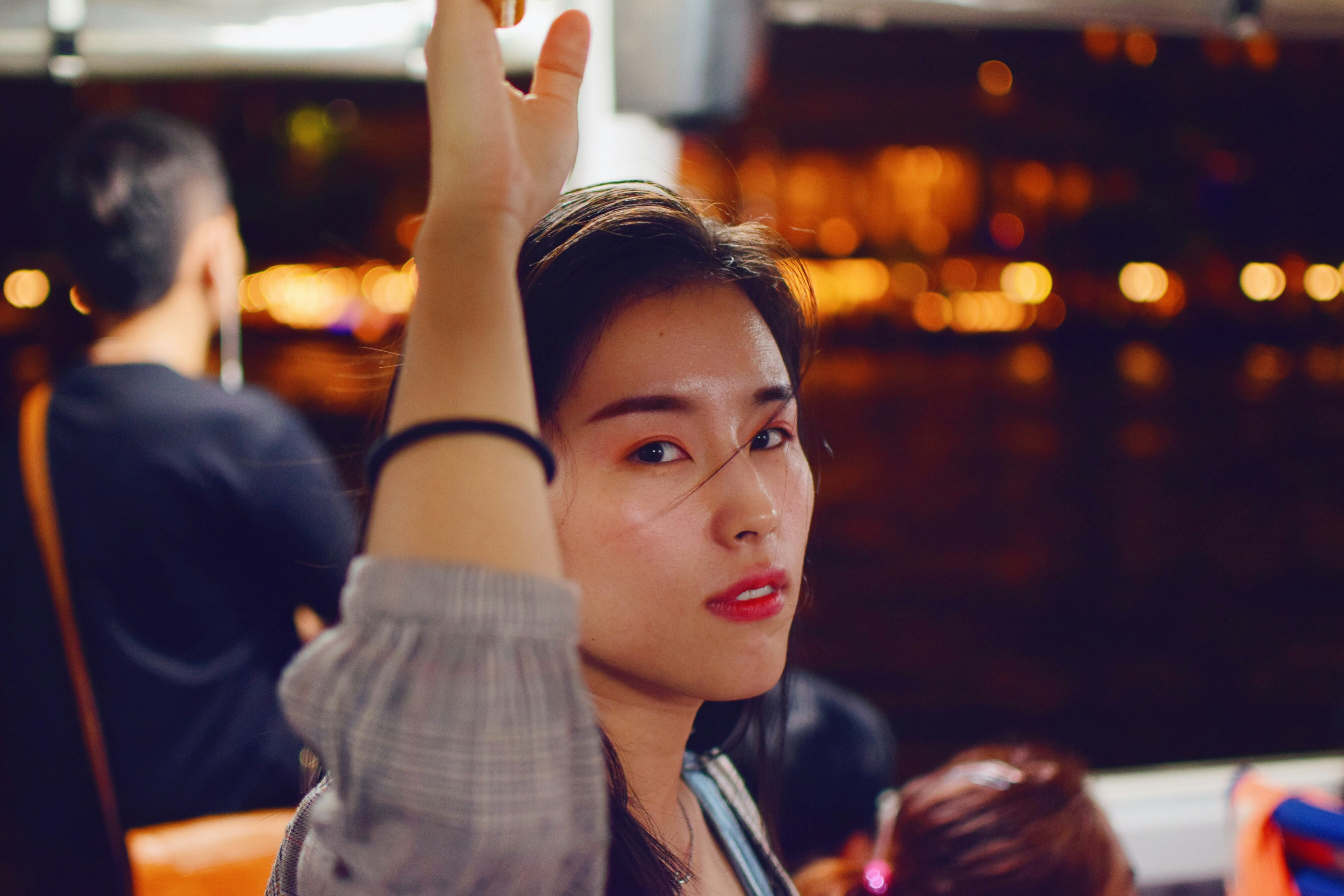 Woman wearing gray long-sleeved shirt glancing her right side photo ...