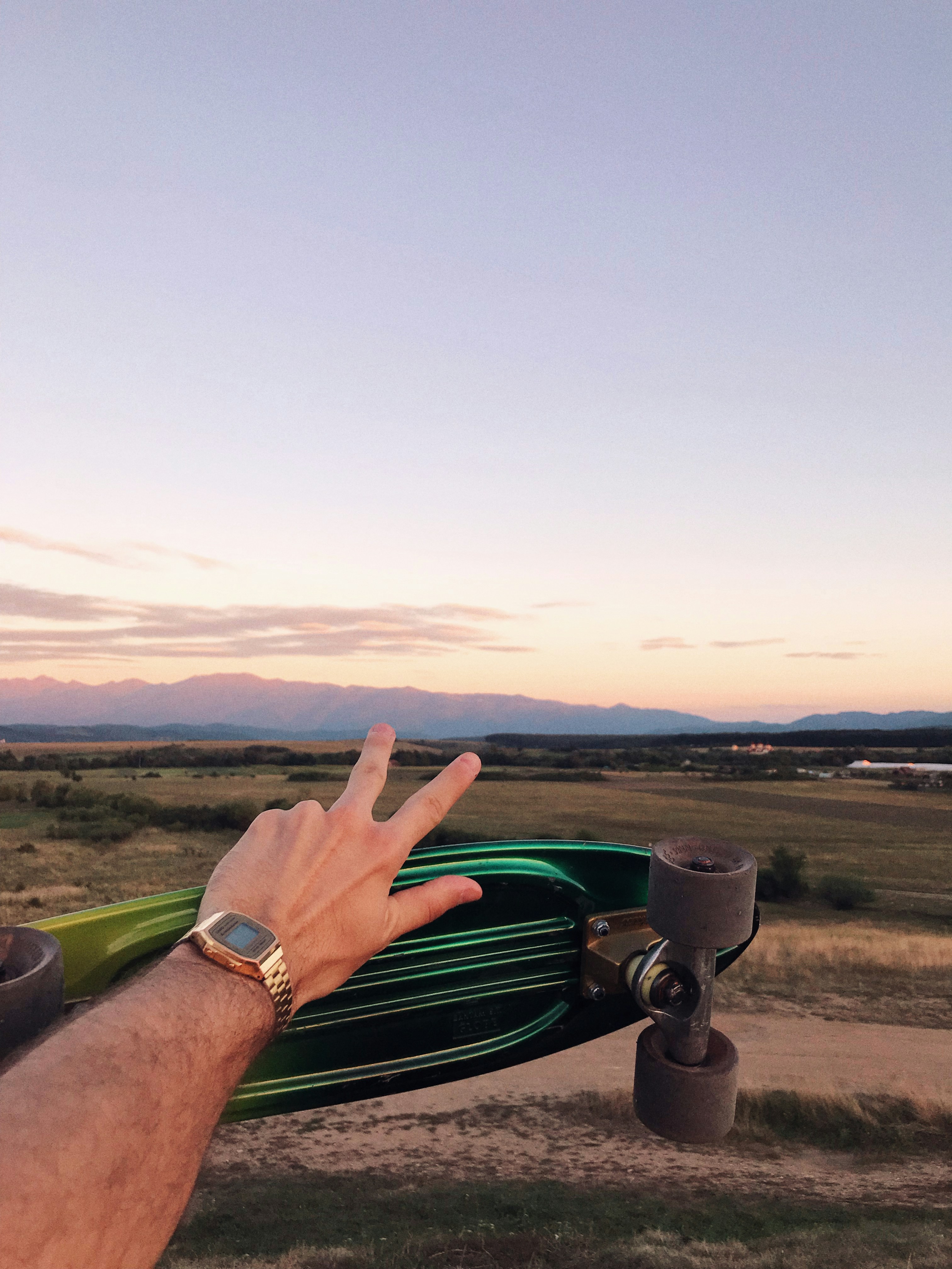 Low-Altitude Sunset Ride: Hand, Watch, and Skating Board