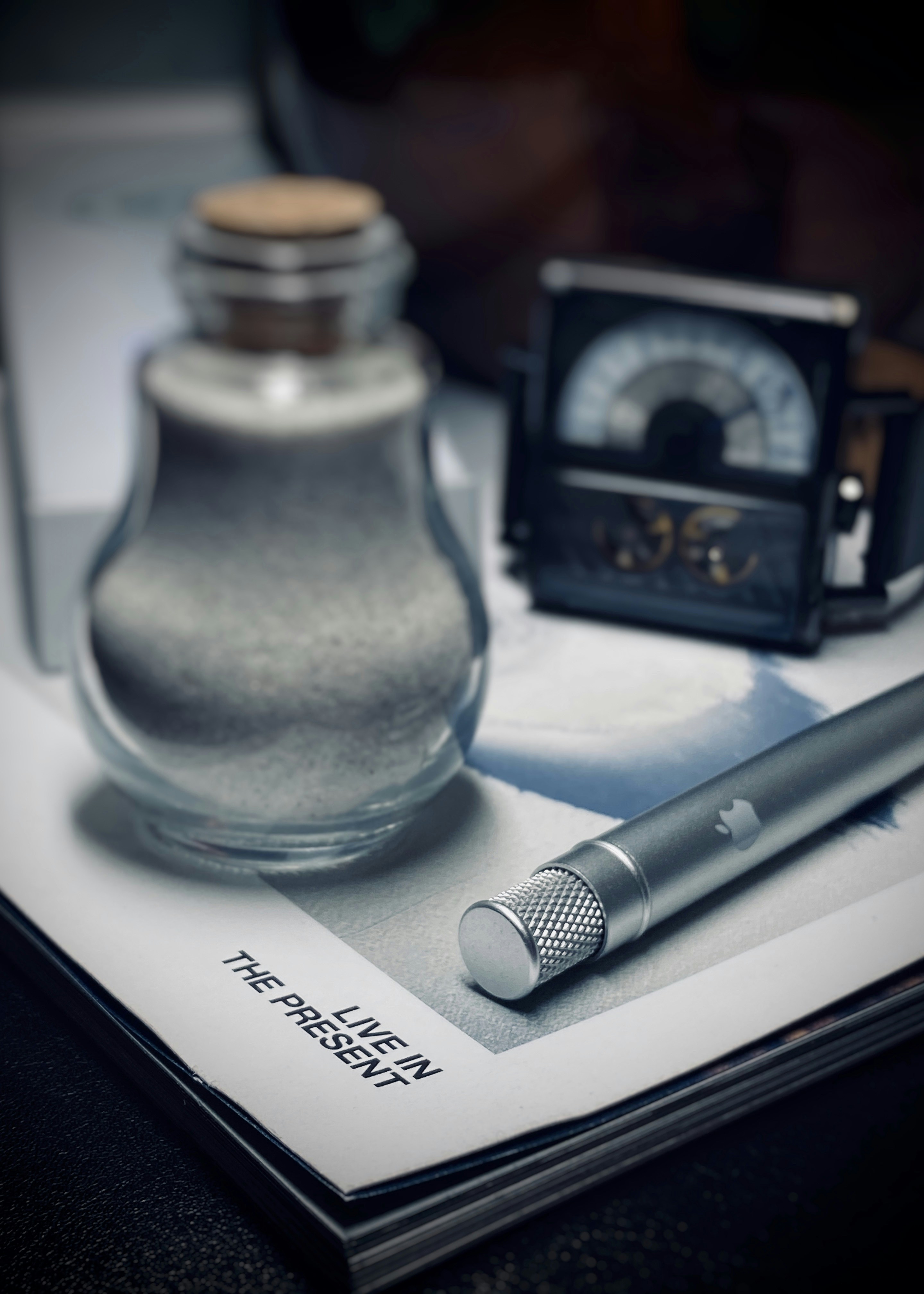 Quiet Precision: Ink Bottle, Knurled Pen, and a Vintage Dial on an Open Page