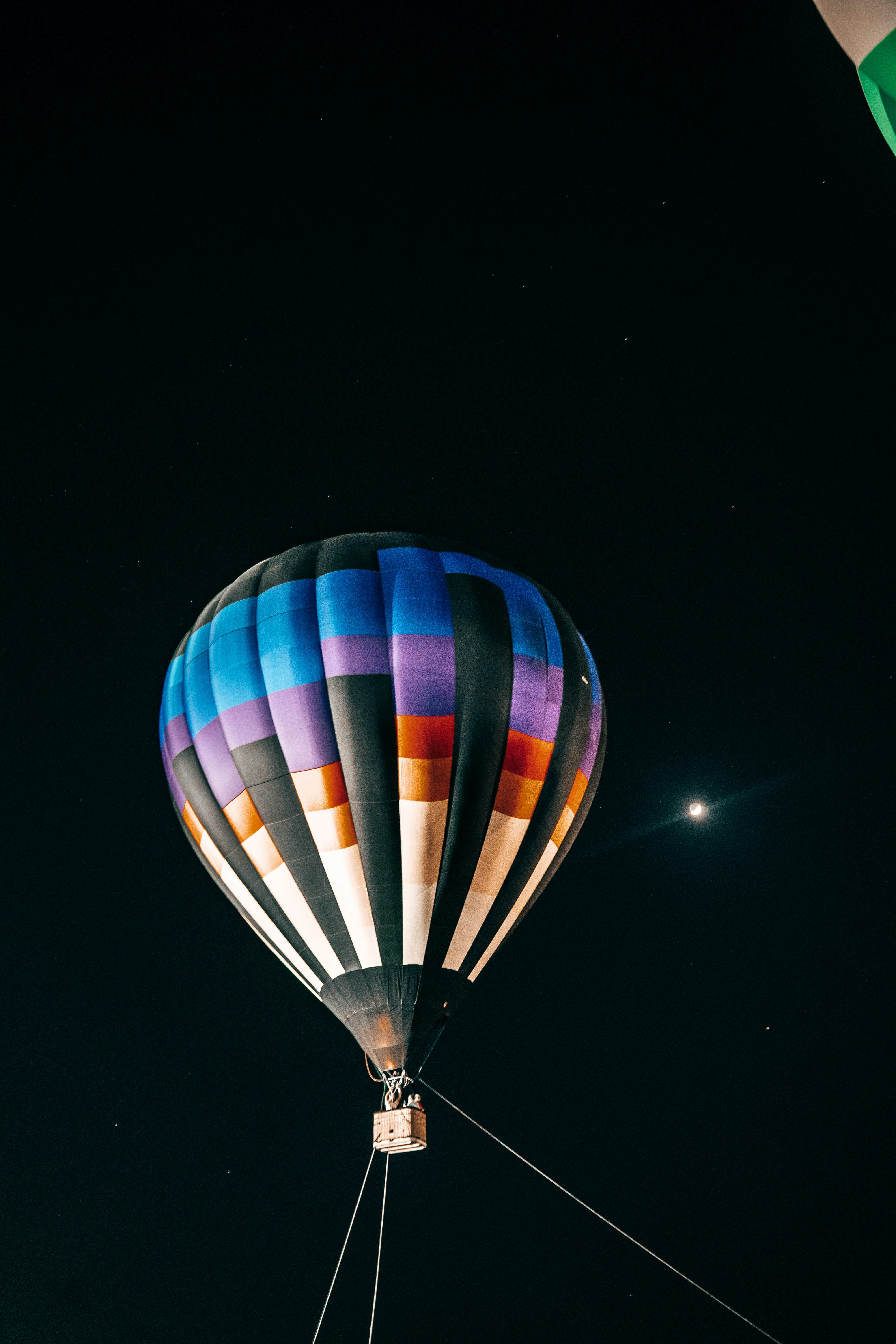 Night Glow: A Multicolored Balloon Rises Against the Starry Sky