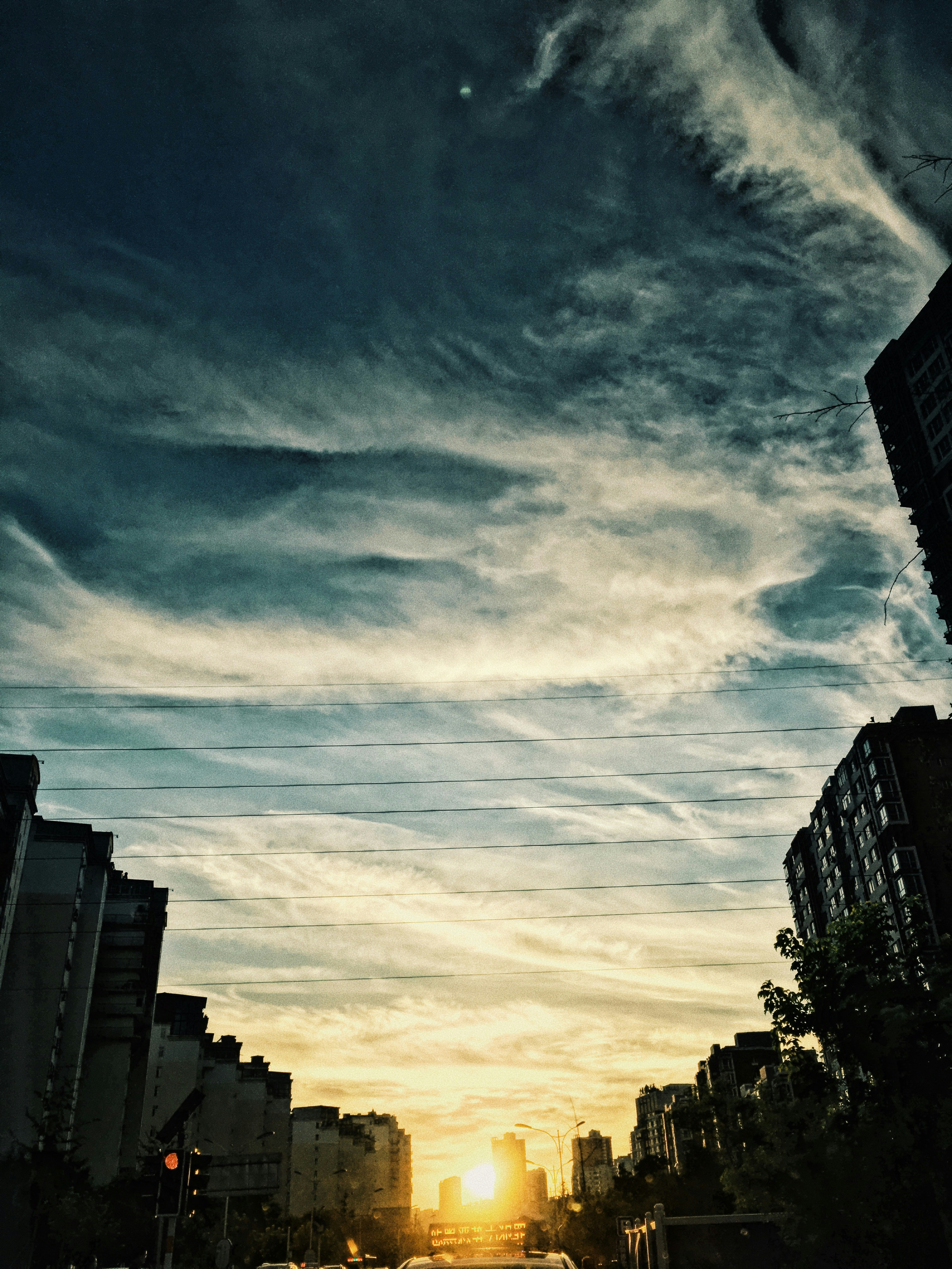 Golden Hour Between Towers: Sunset Over a Streetwide Skyline