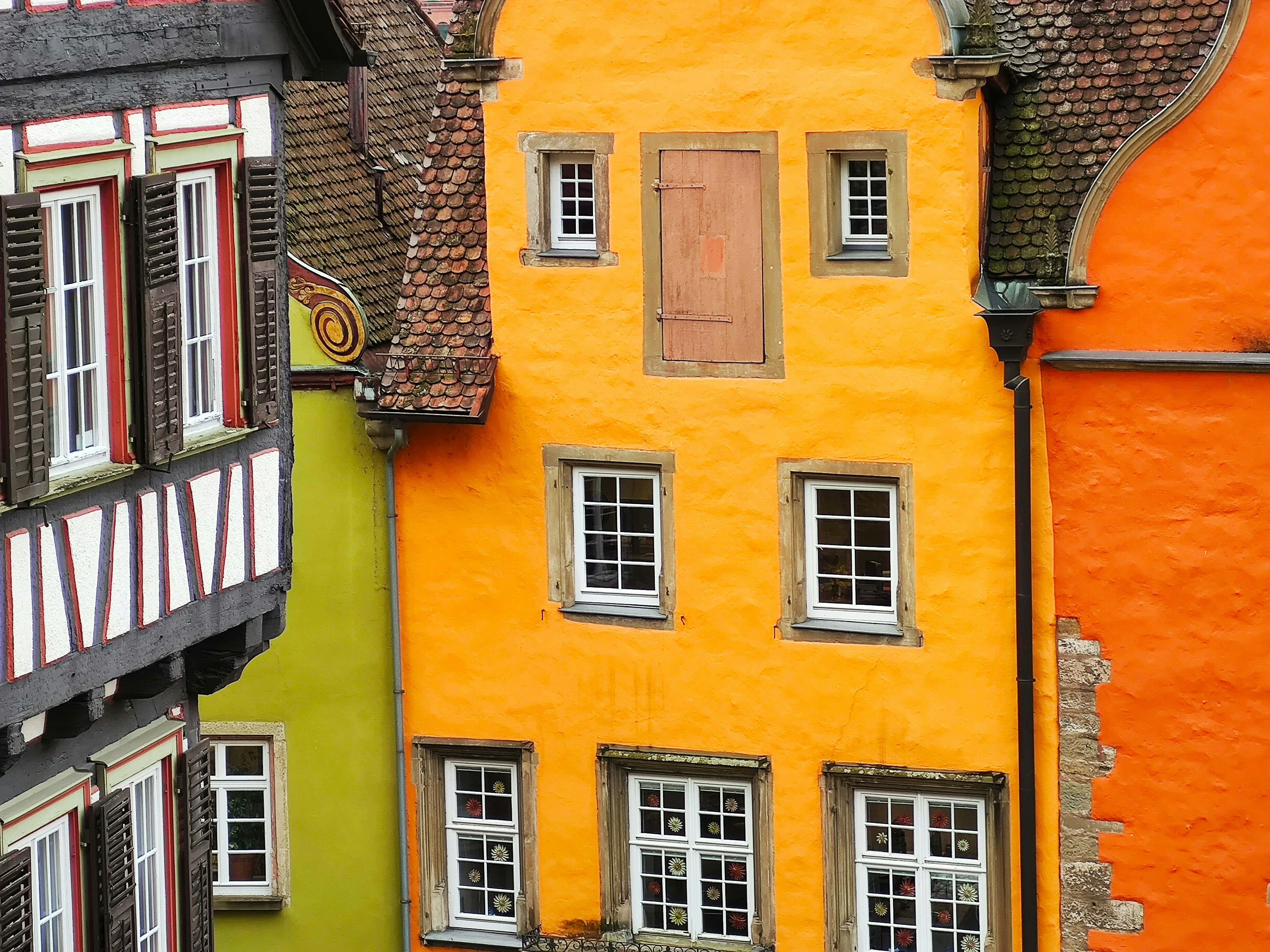 Brightly colored medieval buildings with wooden accents and intricate roof designs.