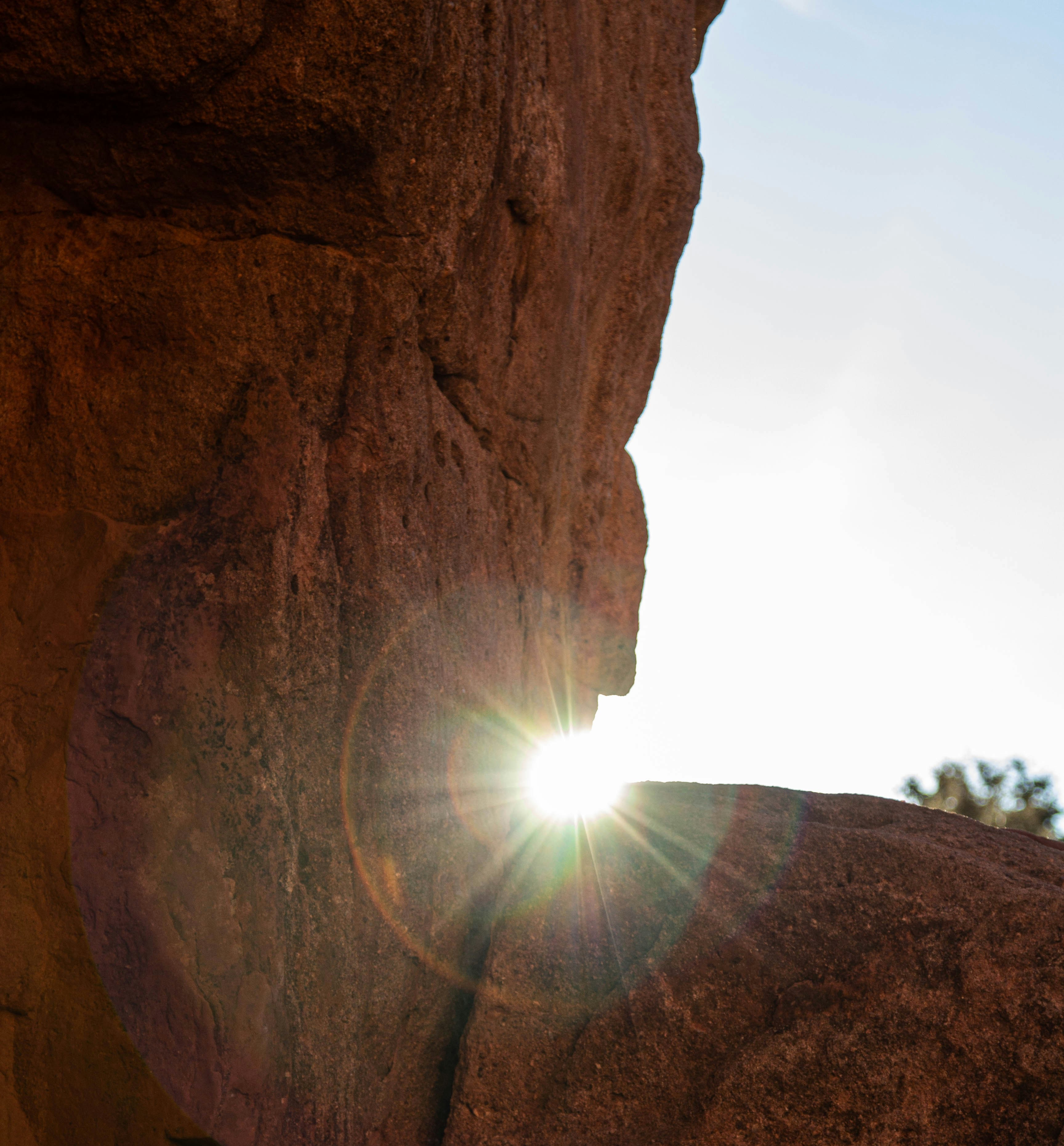Sunlit Crevice: A Gate of Light Between Weathered Red Rock