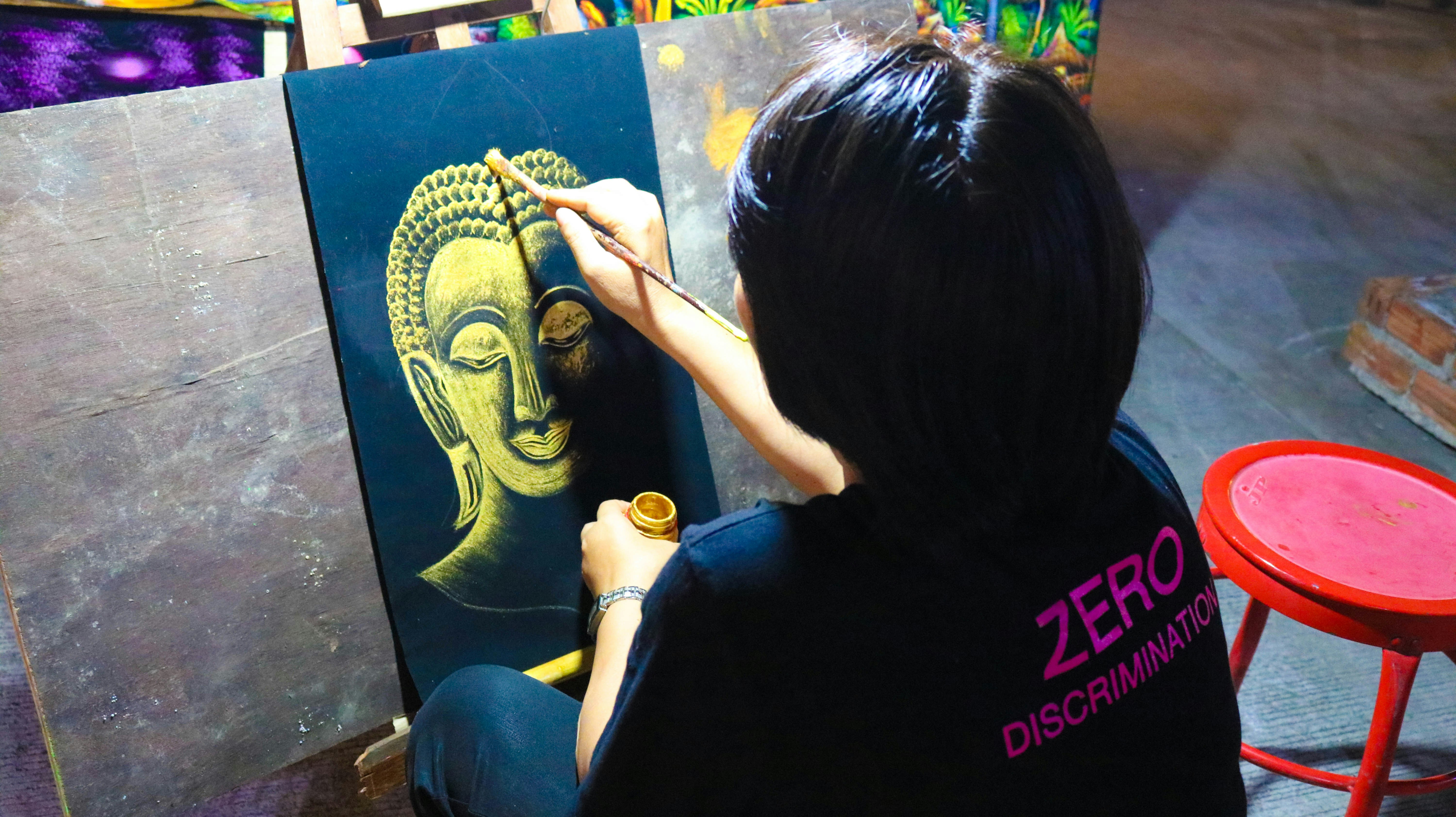 Gold Buddha in a Dim Studio: The Painter's Quiet Hand at Work